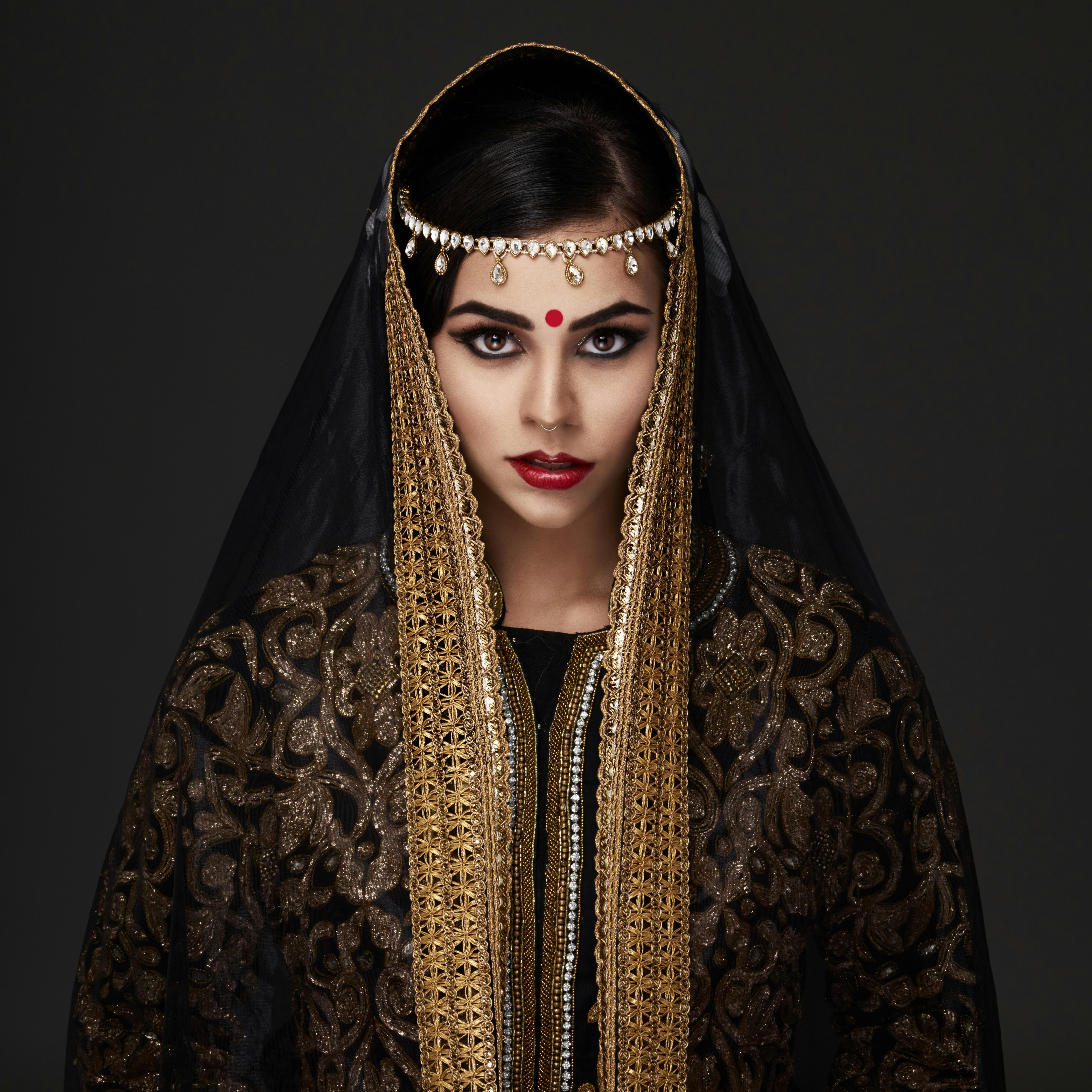 a woman wearing a veil and a head piece