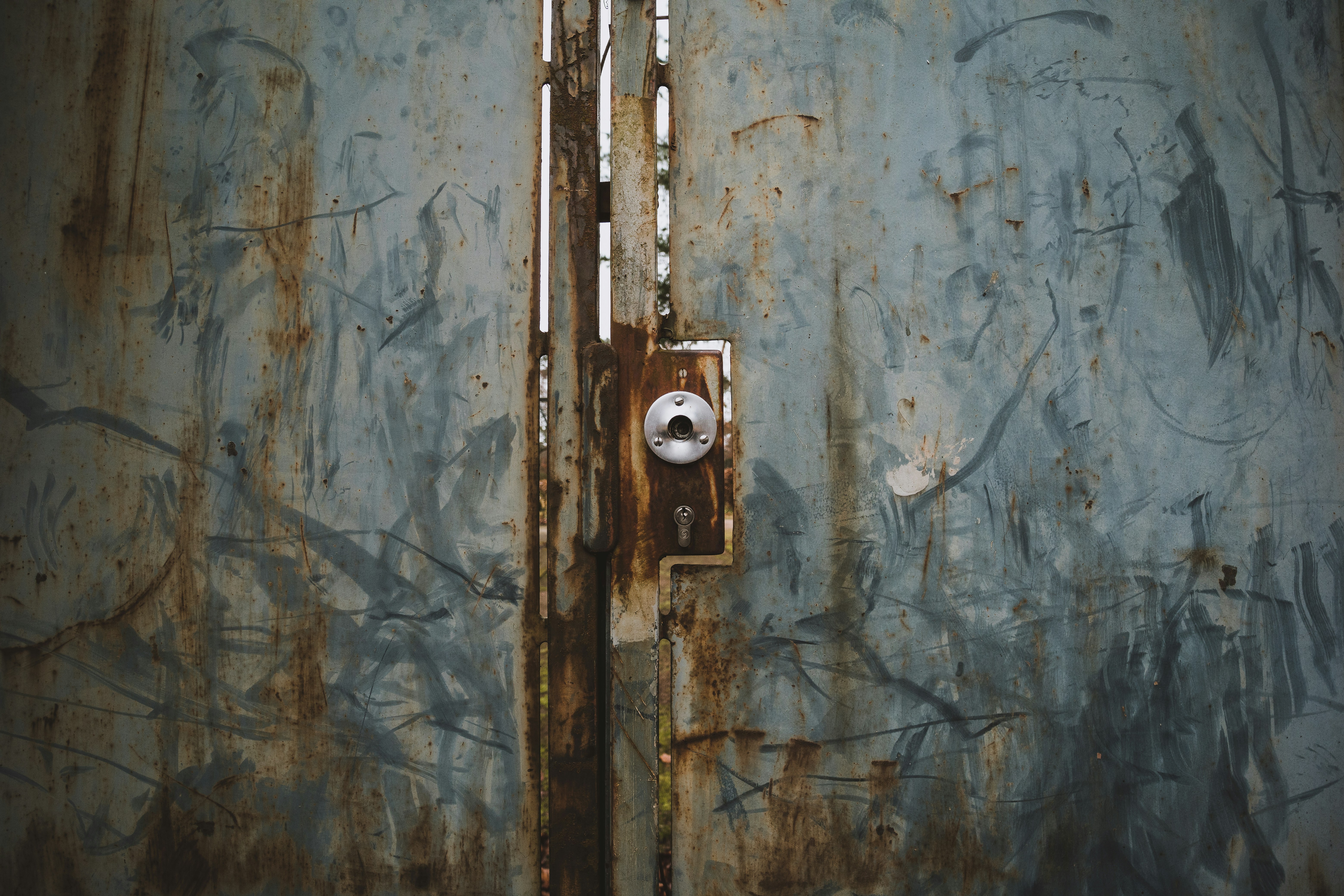 A rusted metal door with a lock on it photo – Free Desolate Image on ...