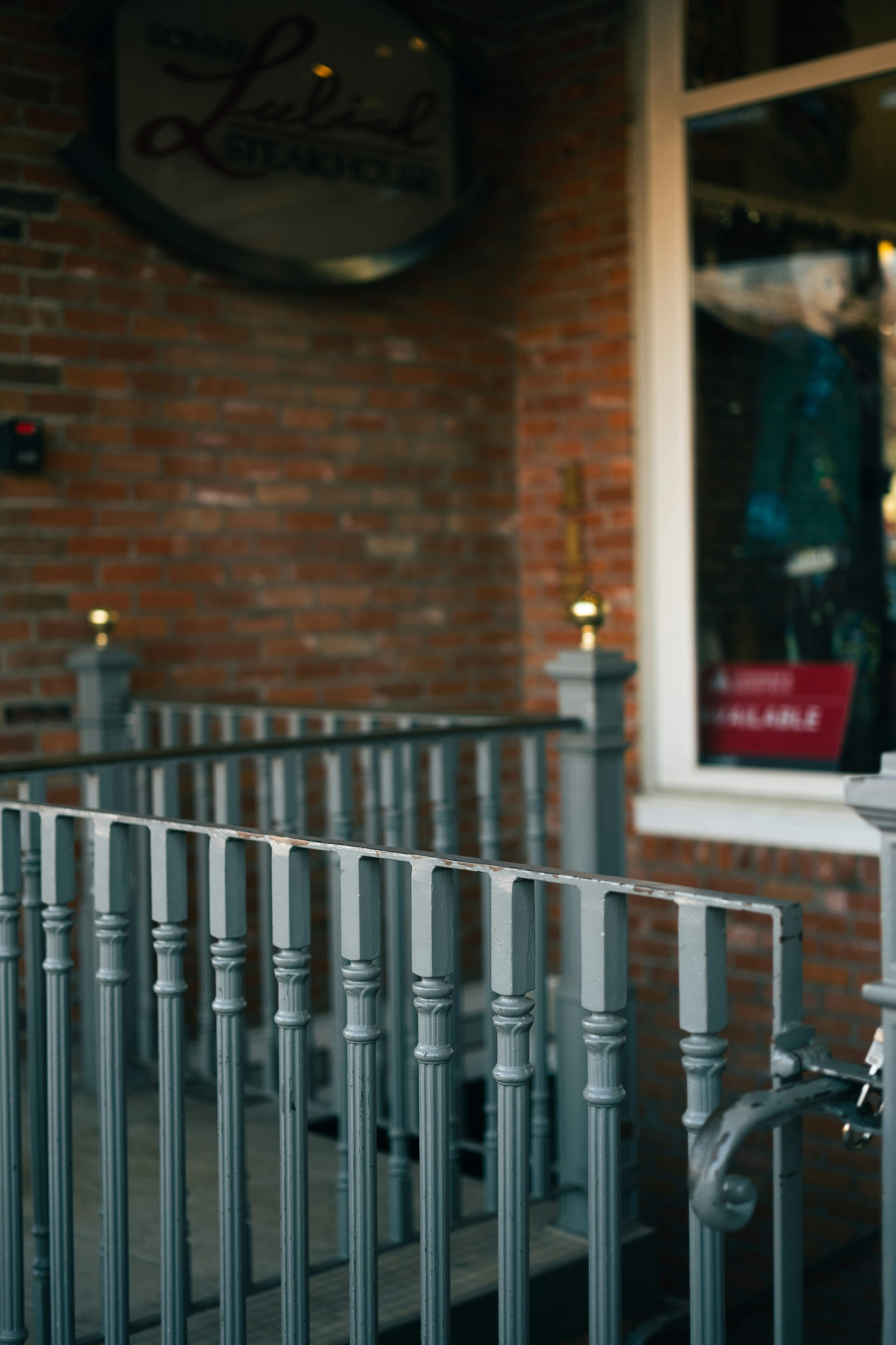 A metal railing outside of a store front photo – Free Banister Image on ...