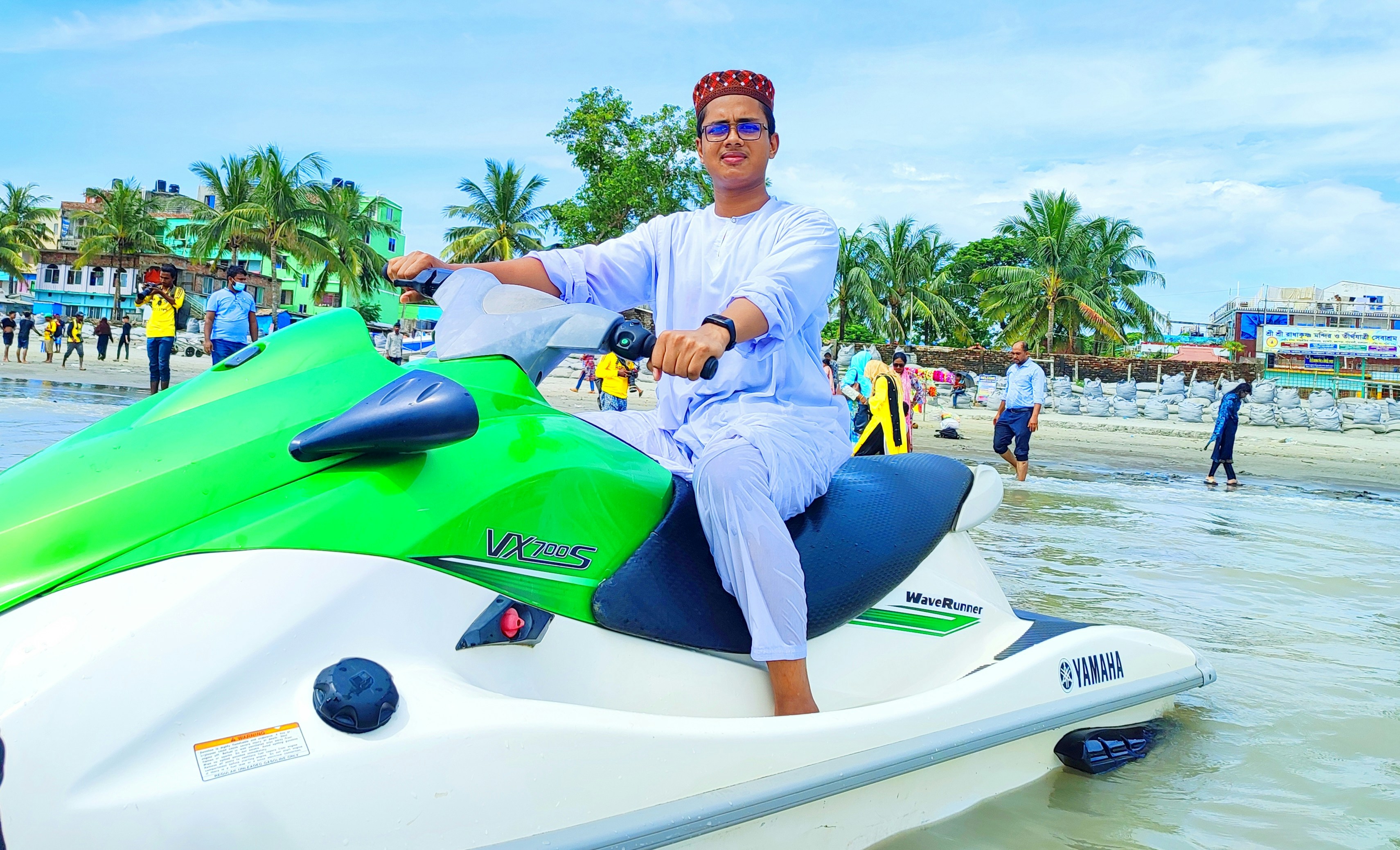 Palm-Side Breeze: Rider on a Lime Yamaha Jet Ski at Sunny Beach