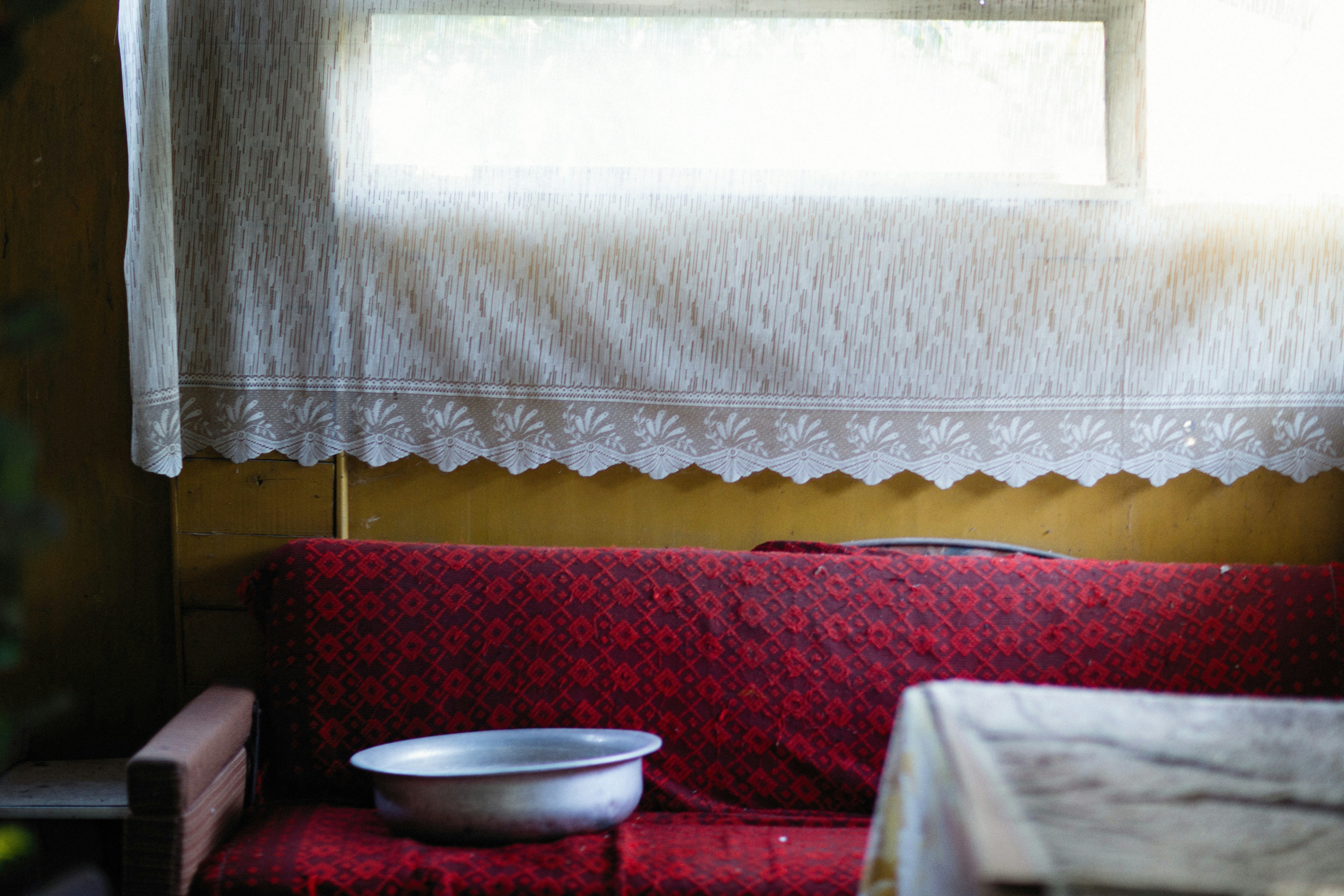 Red Velvet Nook Beneath a Lace Curtain