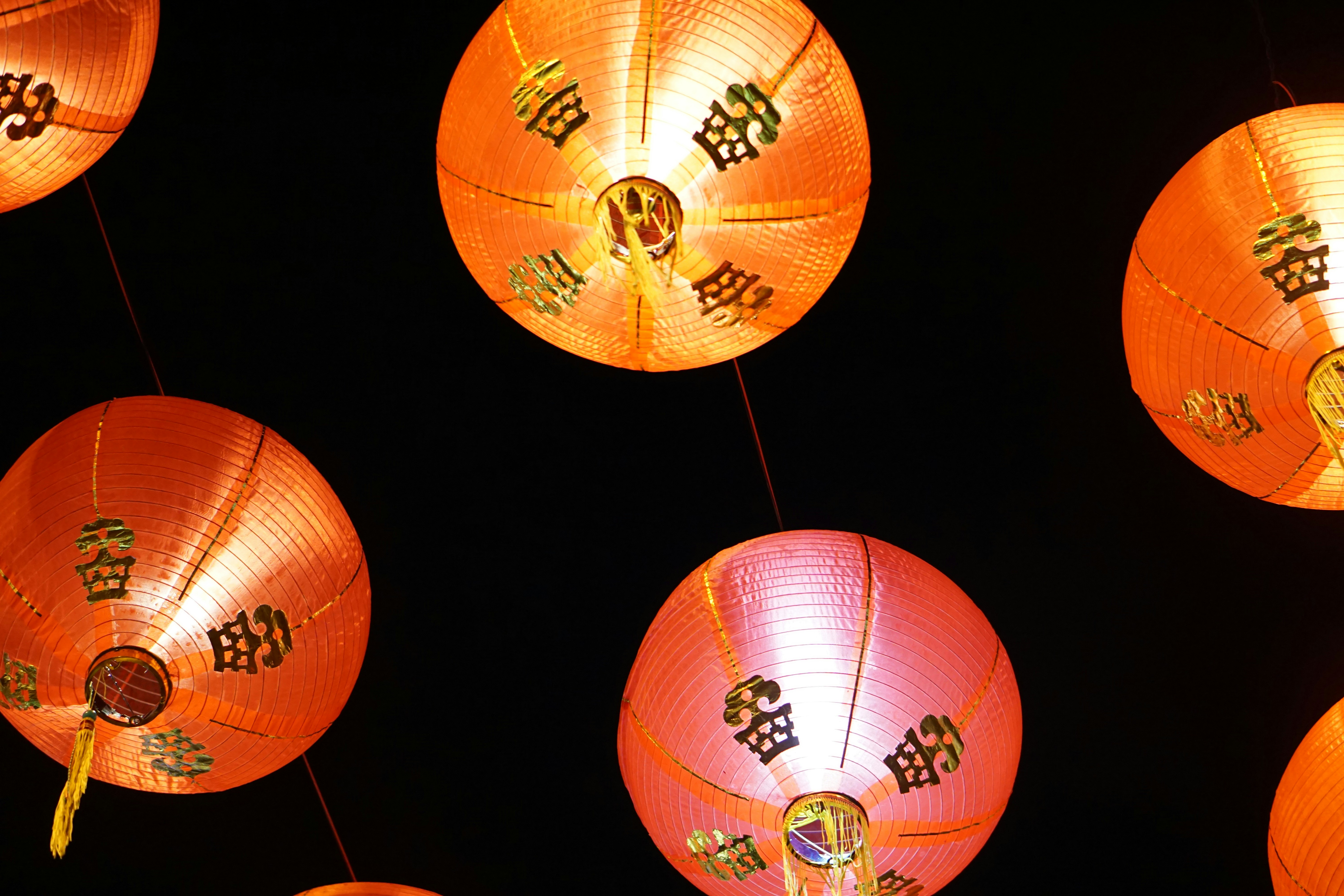 A group of orange lanterns hanging from strings photo – Free Indonesia ...