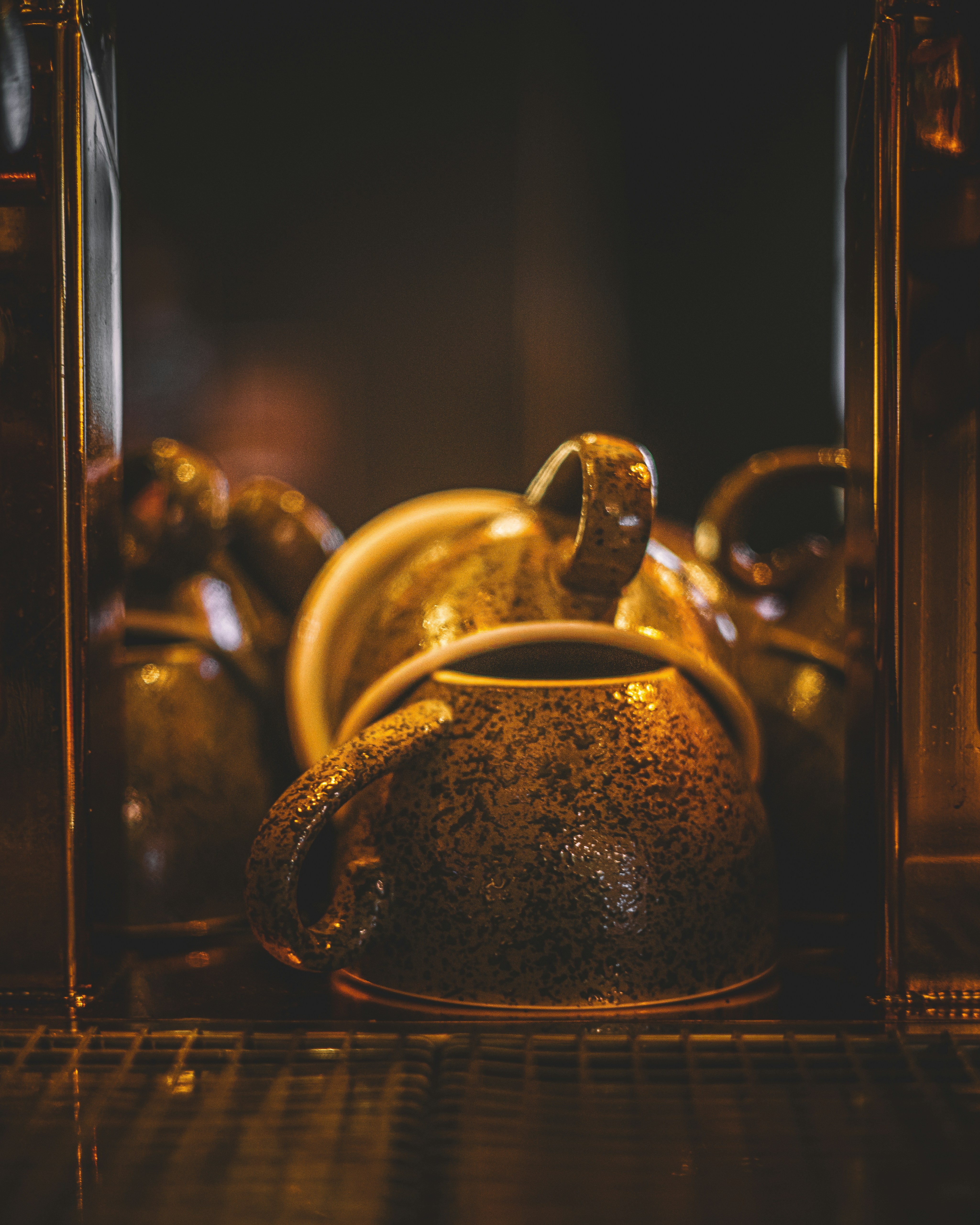 Copper Glow in the Cabinet: A Timeworn Mug Stack