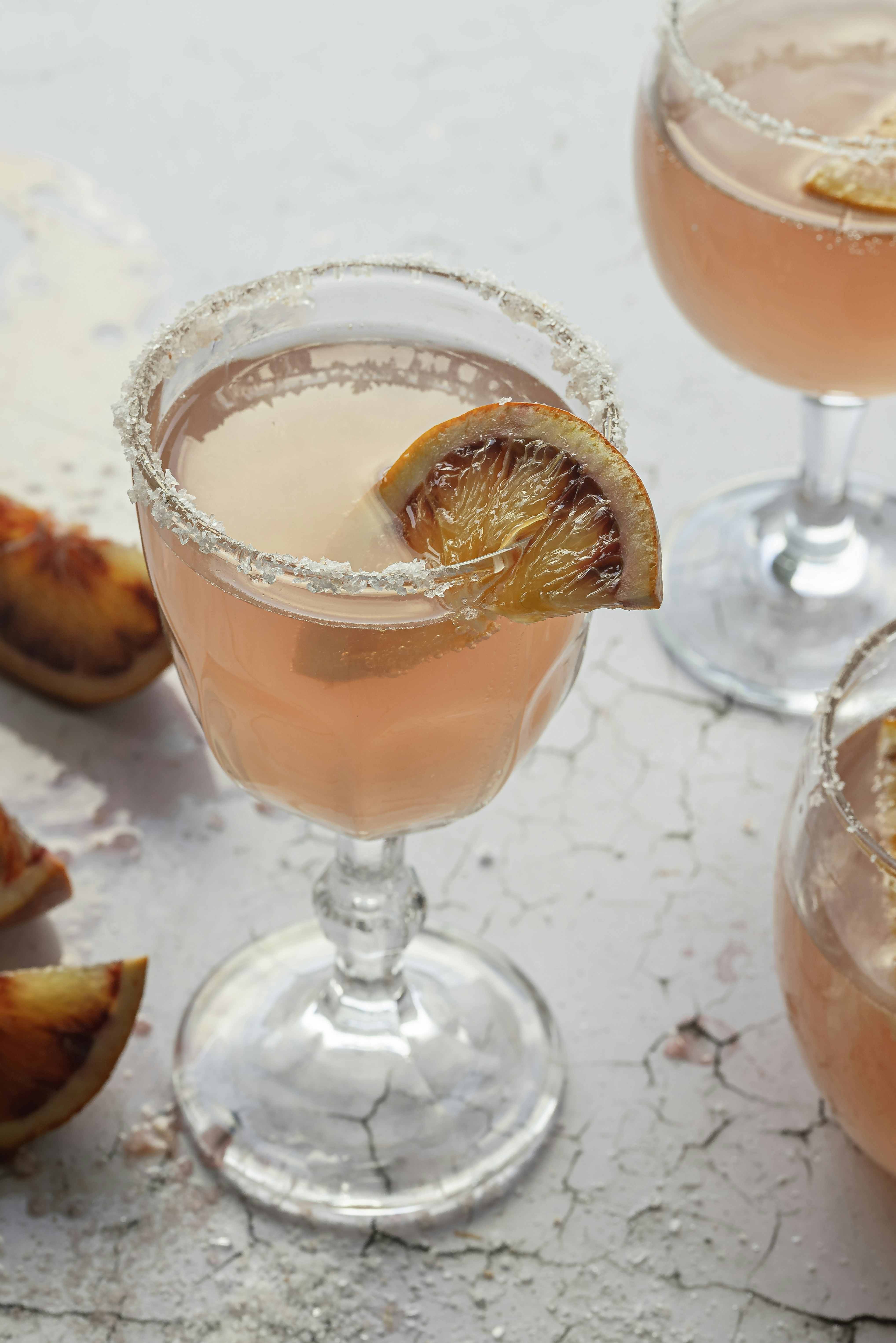 Sugar-Rimmed Rose Cocktail on a Cracked Marble Stage