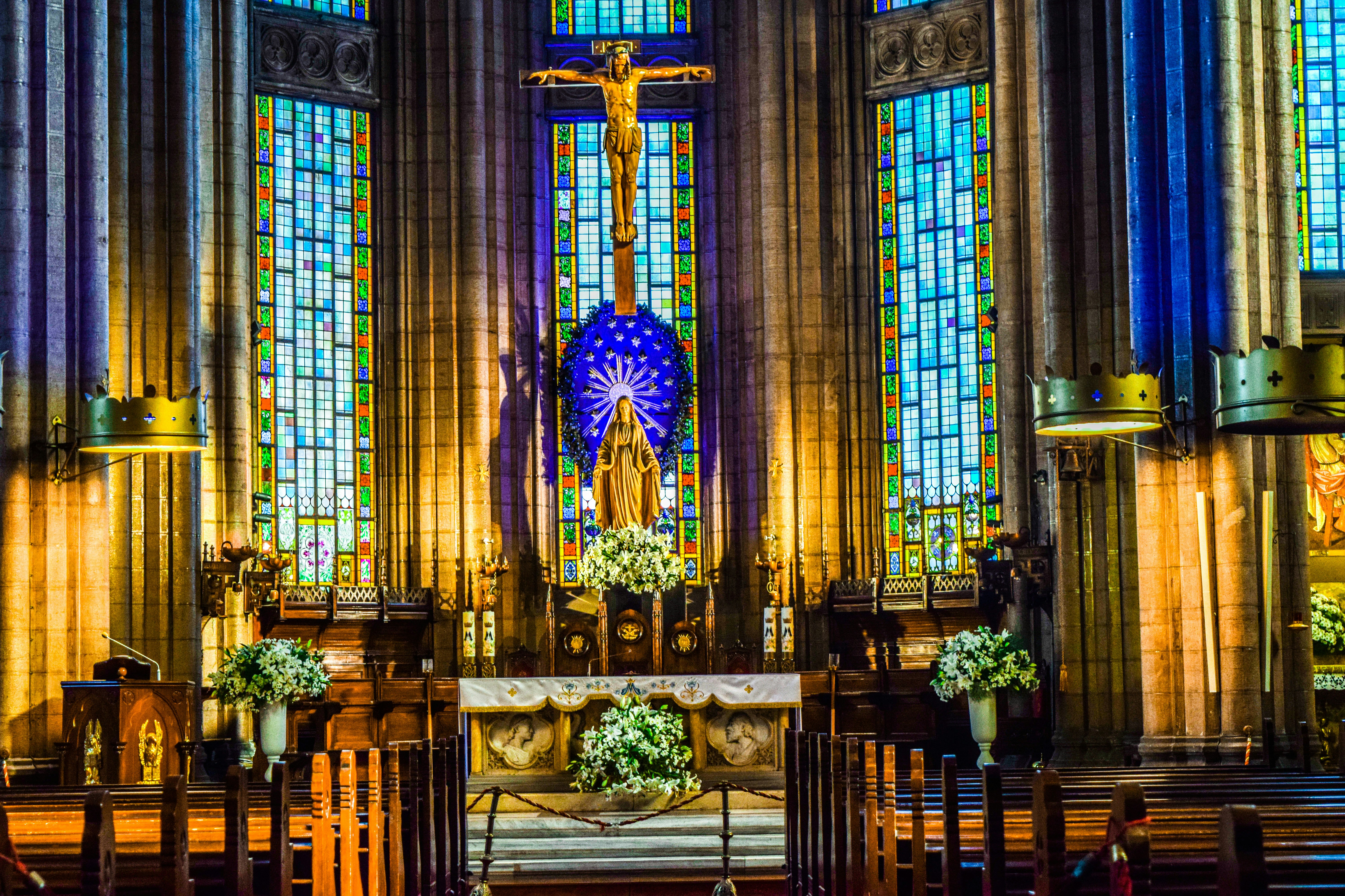 a church with stained glass windows and pews
