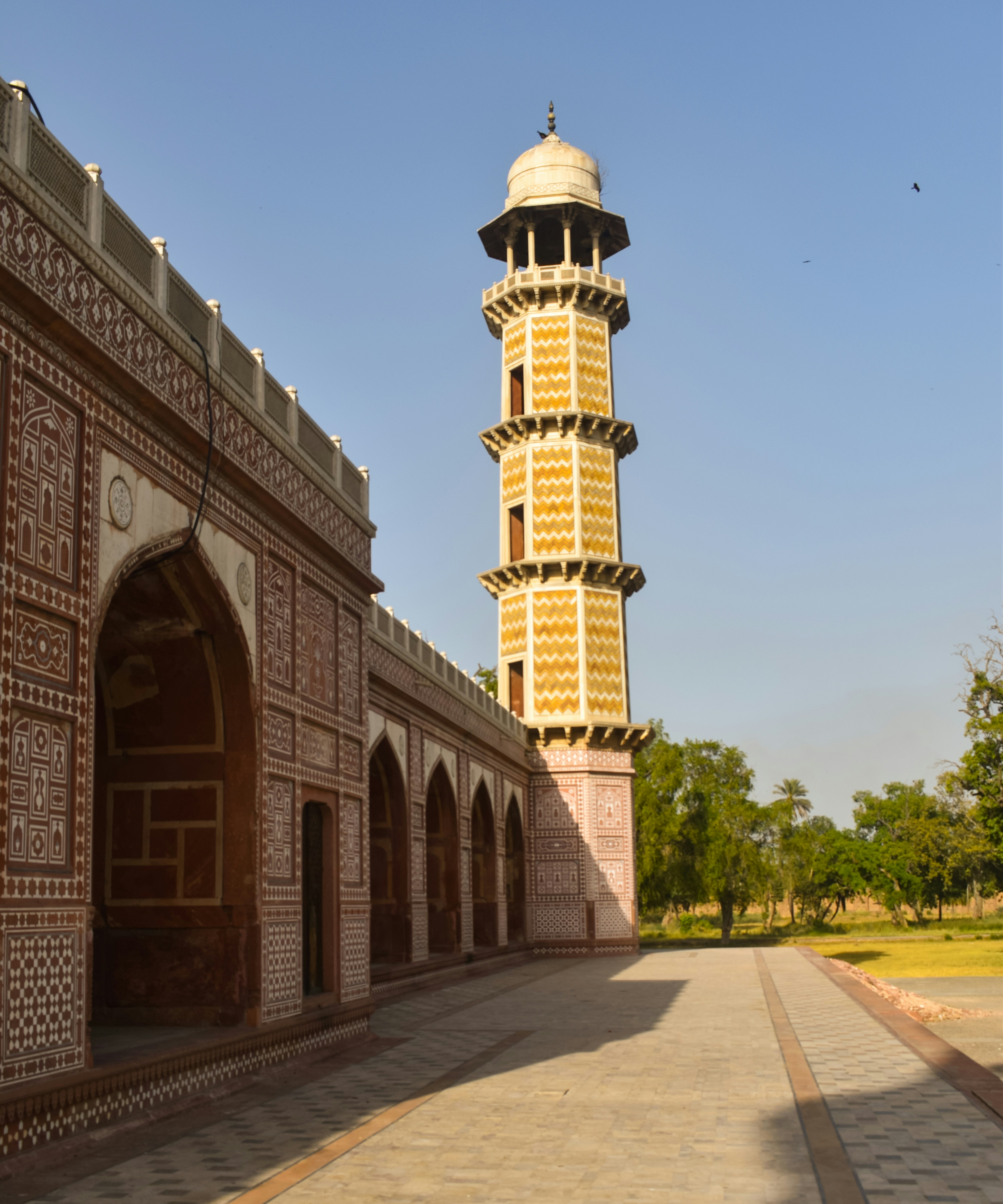 Tomb of Jahangir | a tall tower with a clock on the top of it