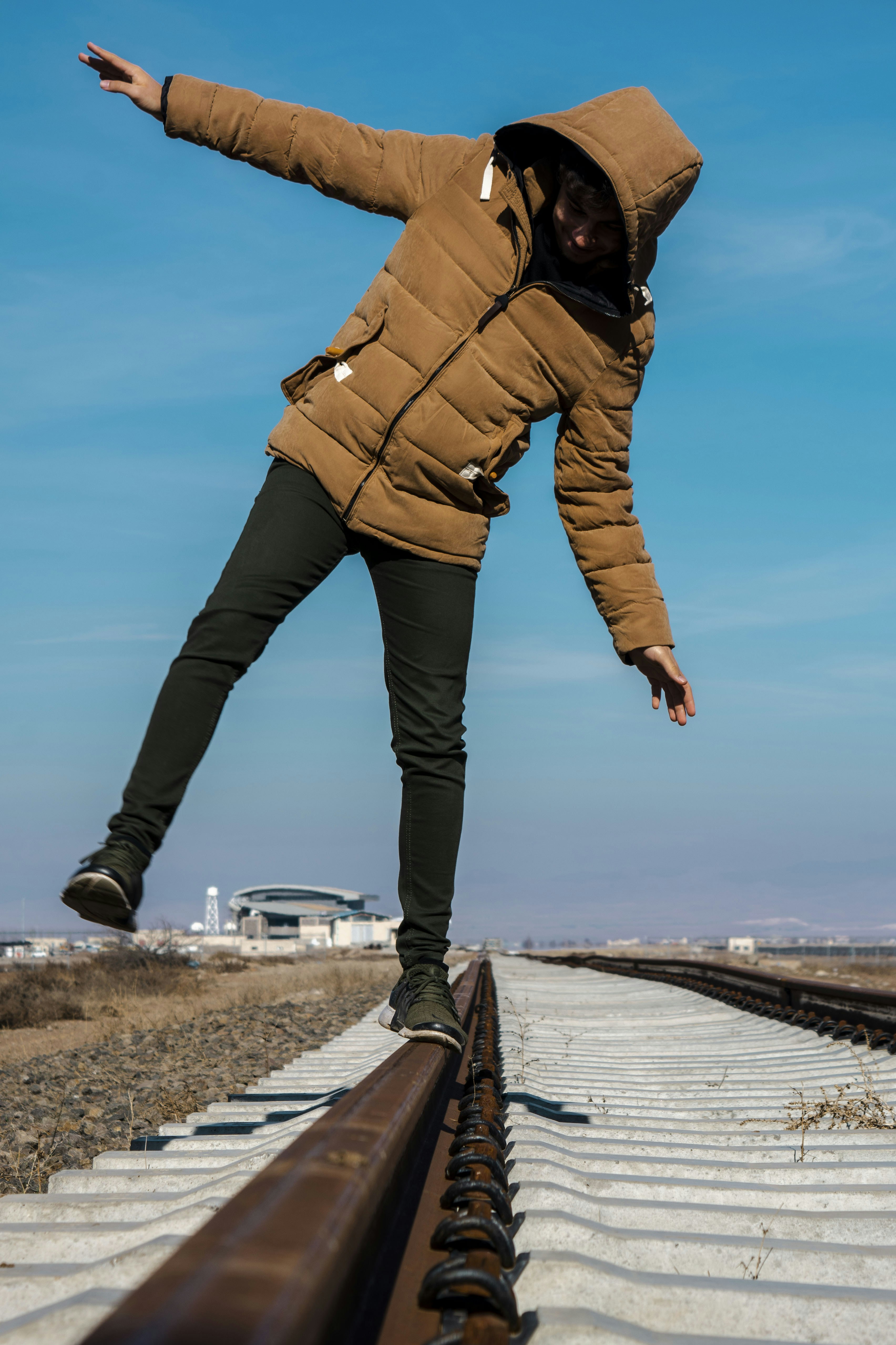 A person jumping a rail on a train track photo – Free Ardabil province ...