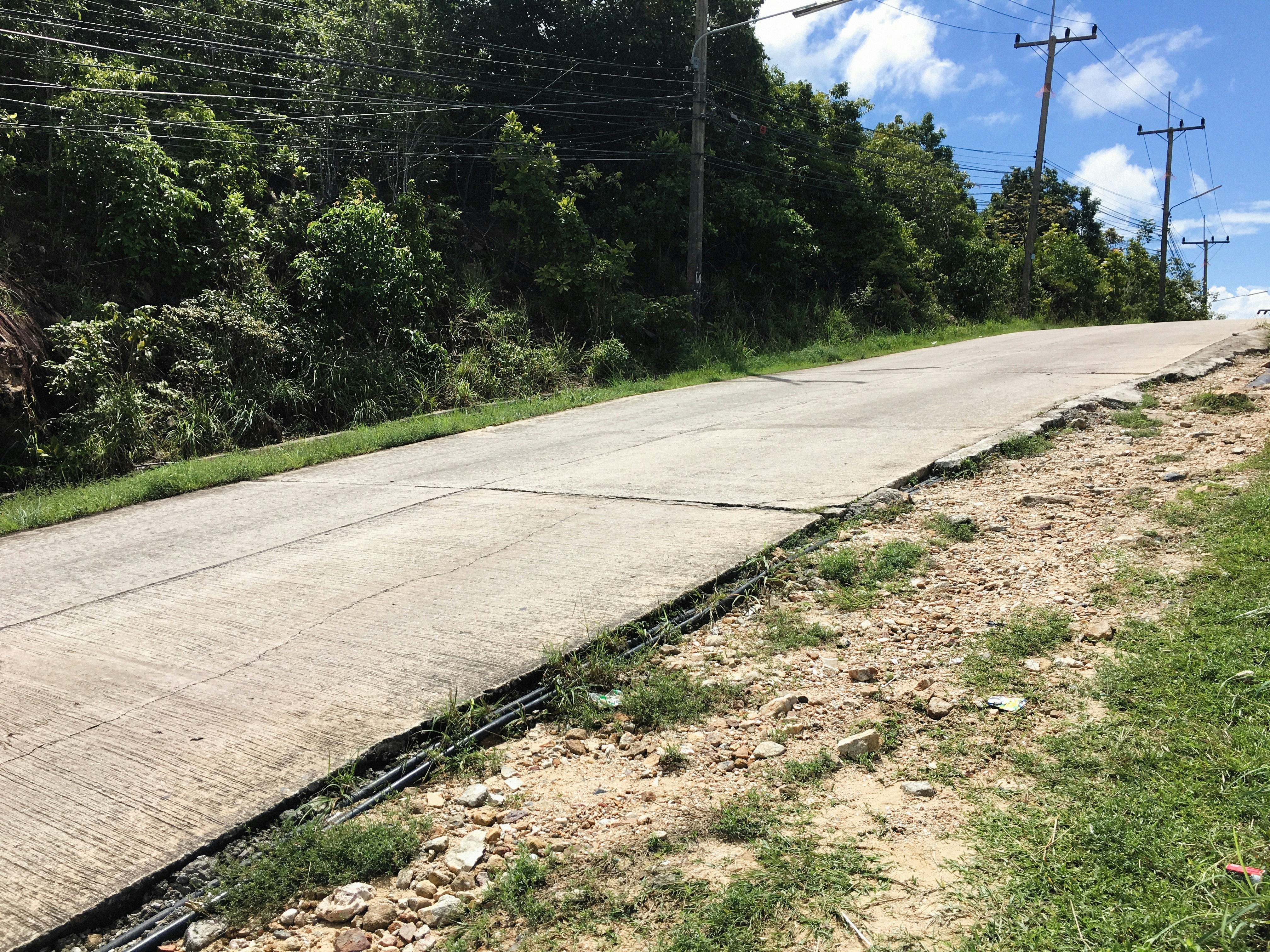 A road with a broken stop sign on the side of it photo – Free Grey ...