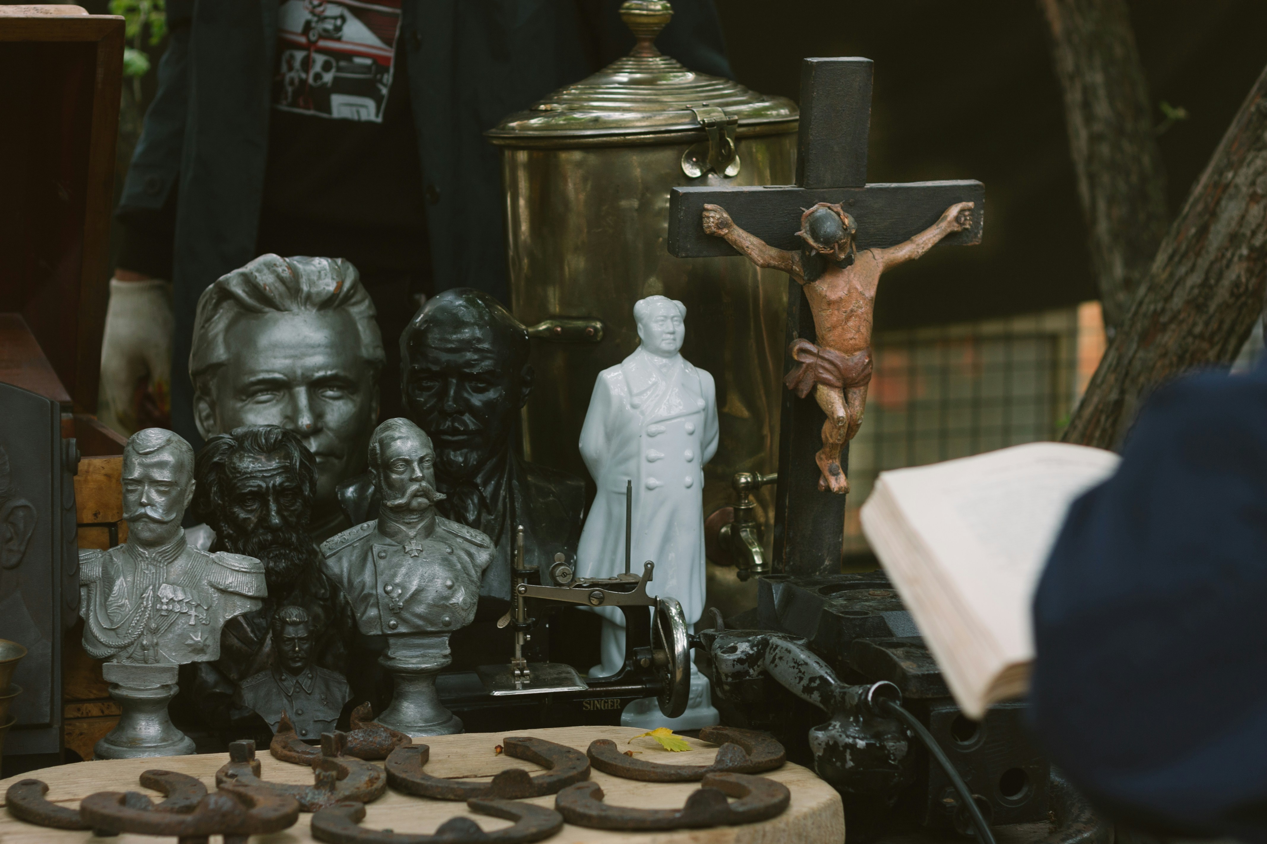Ivory Spotlight: A White Figurine Centered Among Relics in a Vintage Stall