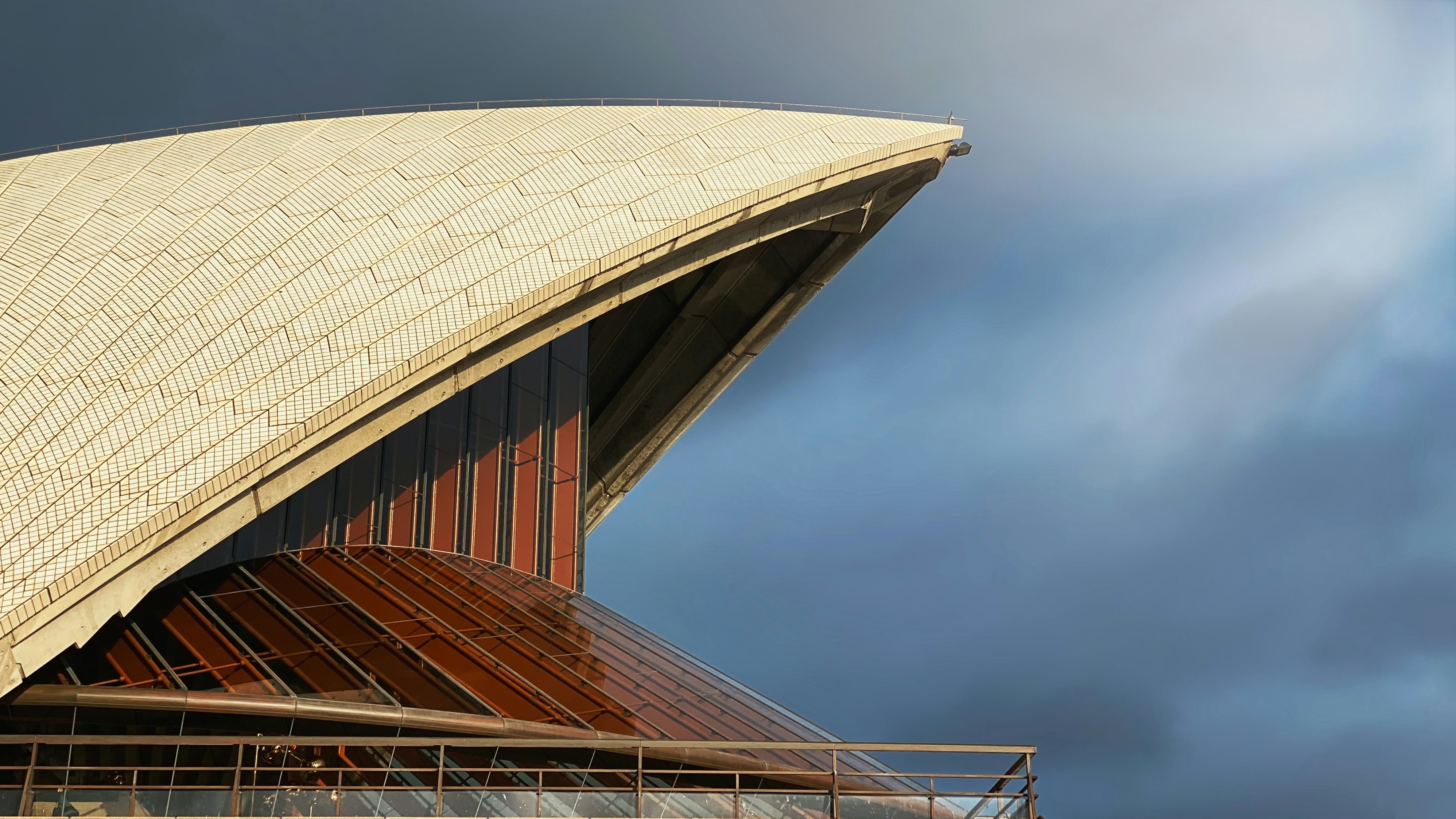 Curved Roof Facets Against a Moody Sky