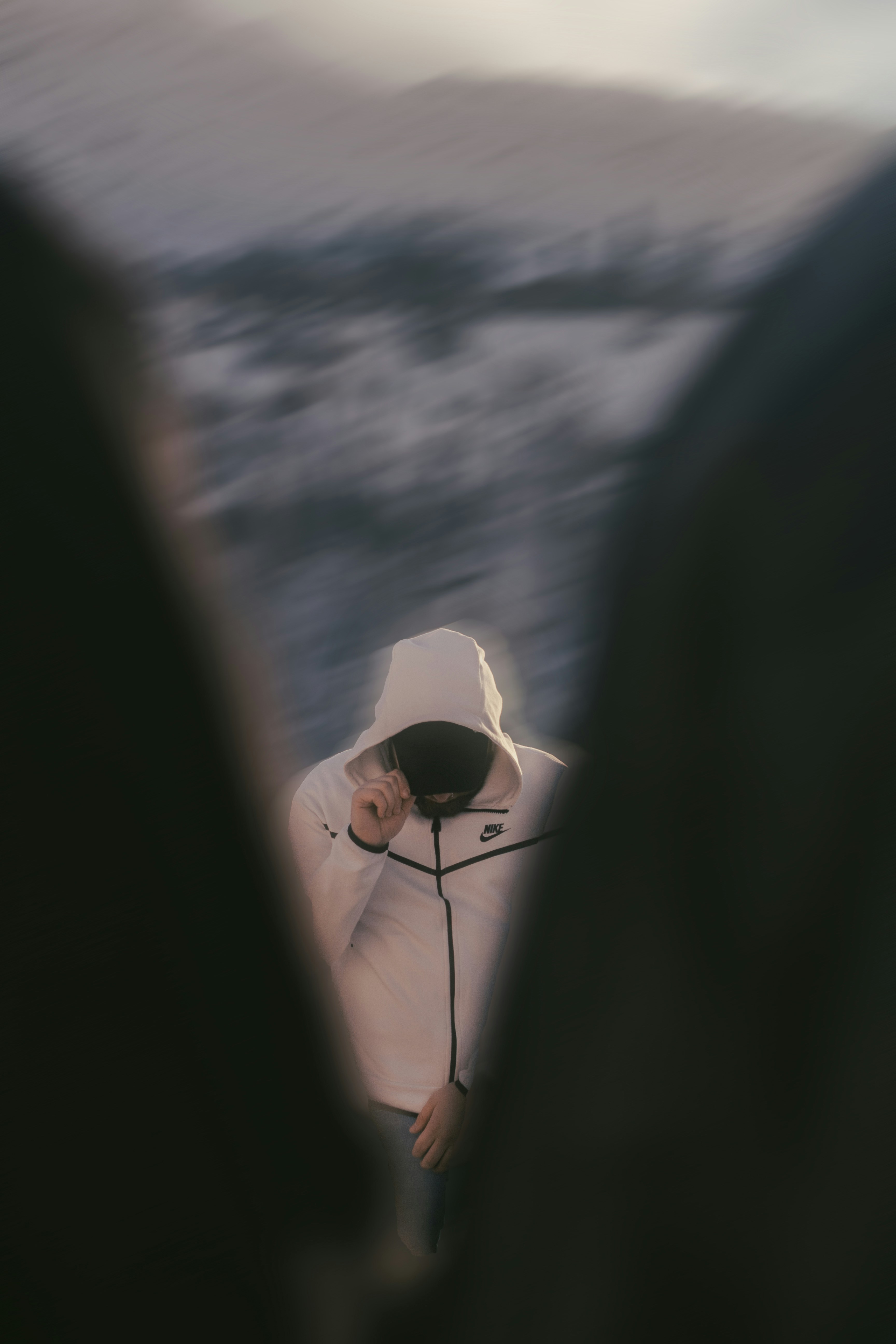 Hooded Figure Framed by Snow and Shadow