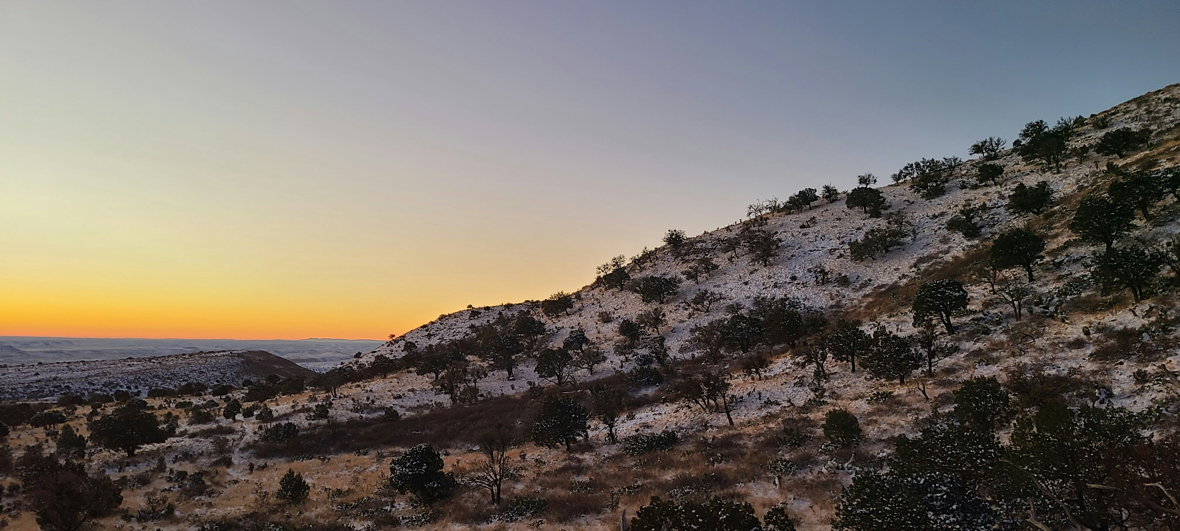 Dawn's Embrace on Snow-Dusted Hills