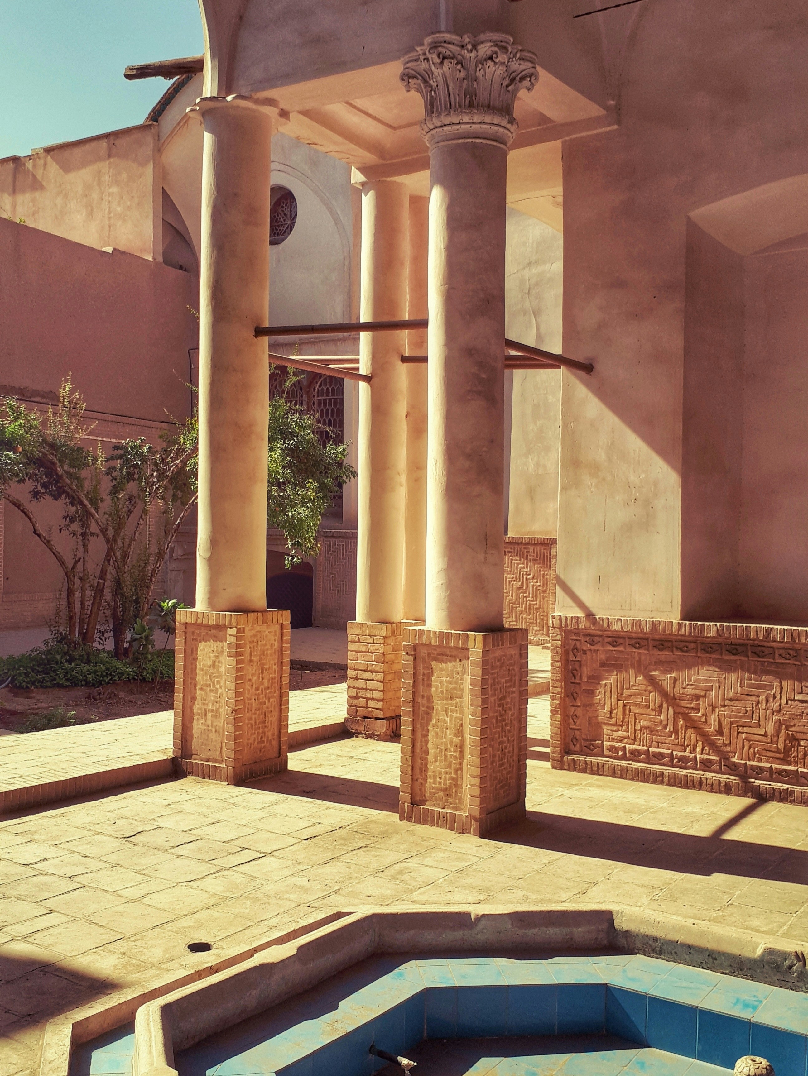 Golden Hour Colonnade: Sunlit Columns Framing a Quiet Courtyard Pool