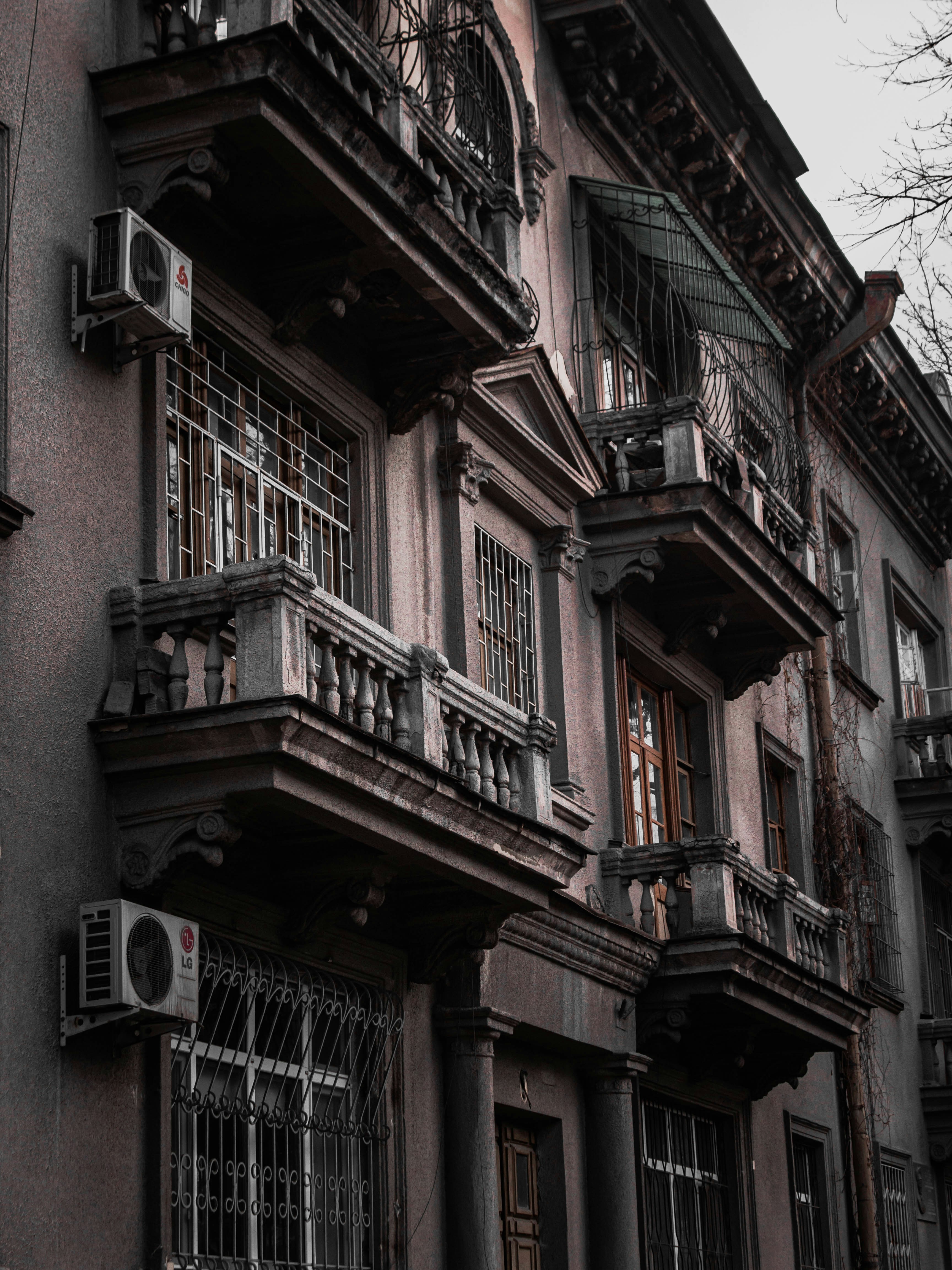 Ornate Balconies and Weathered Facade: A Street of Echoed Architecture