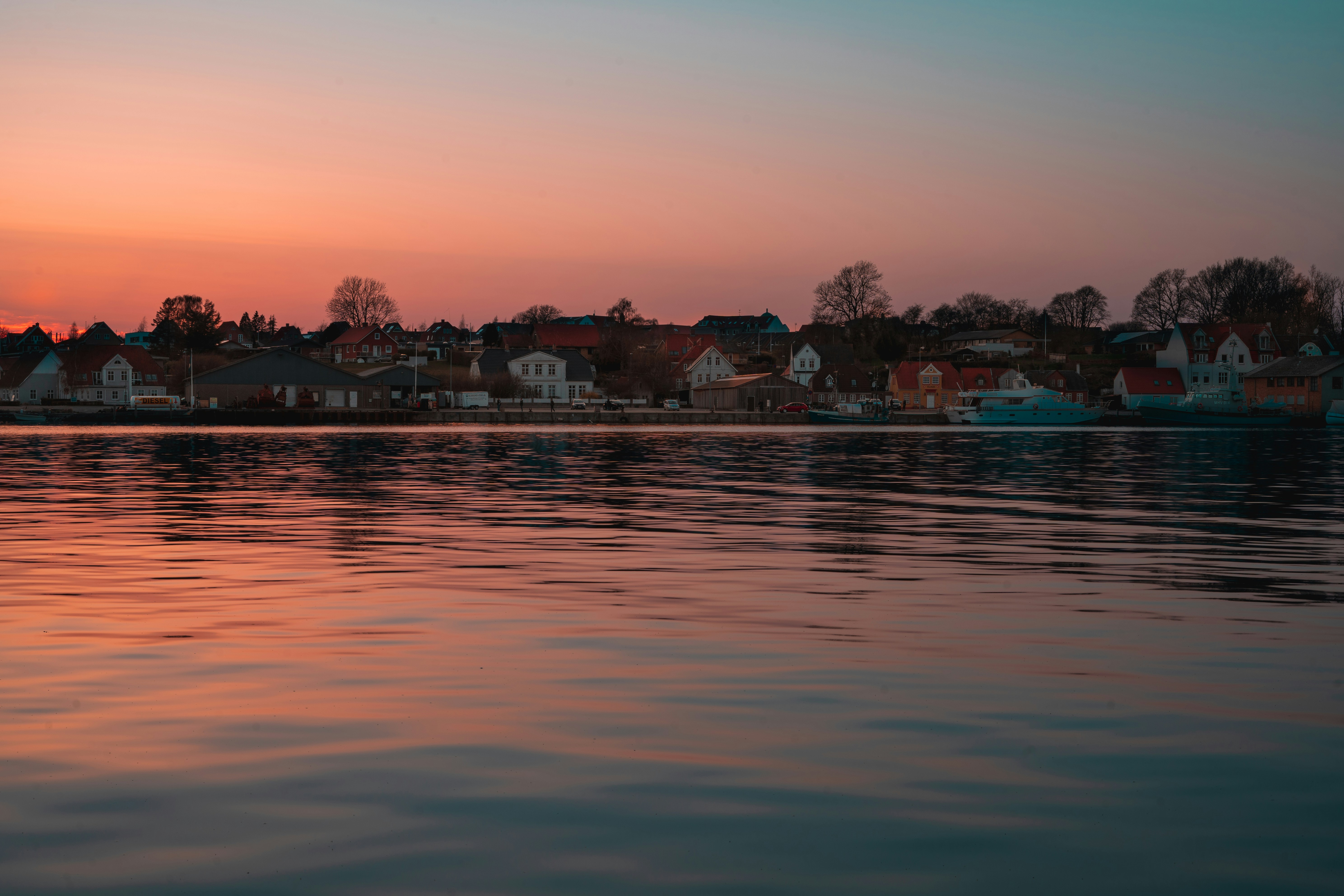 a body of water with houses in the background