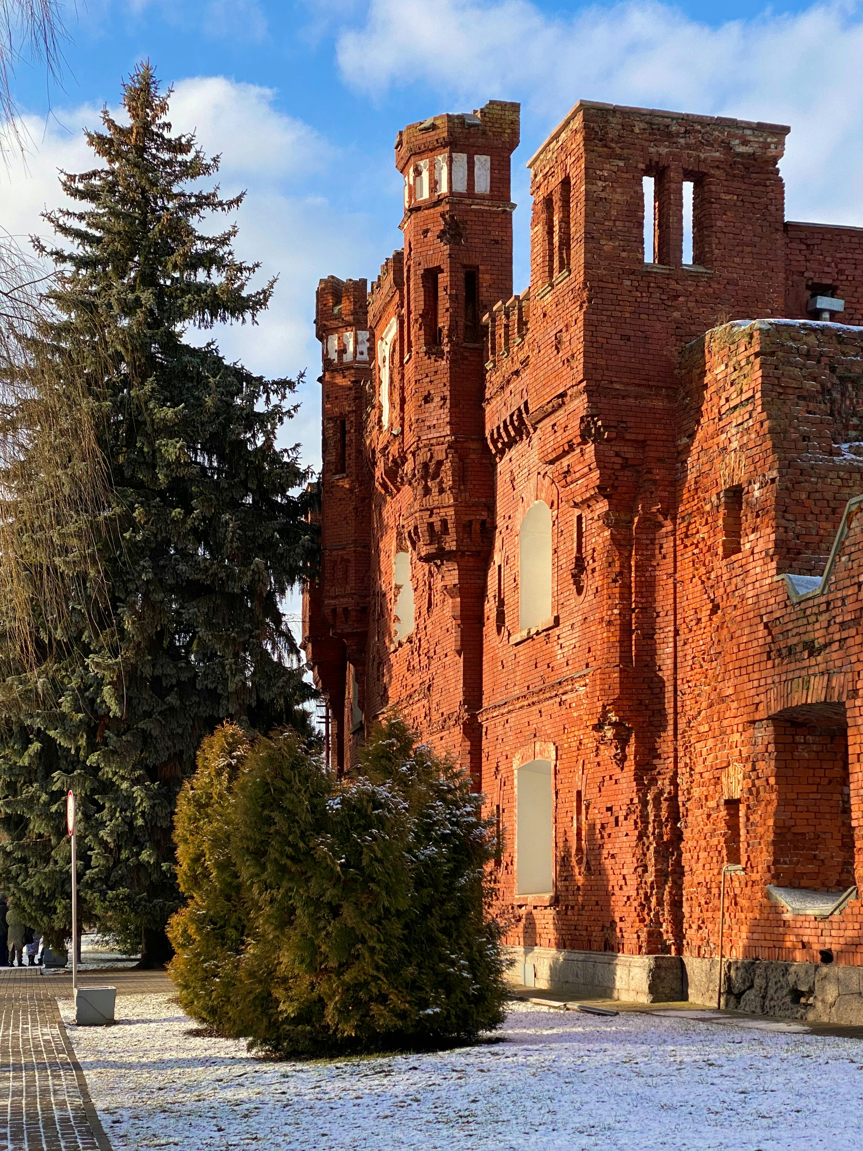 a large brick building sitting next to a tree