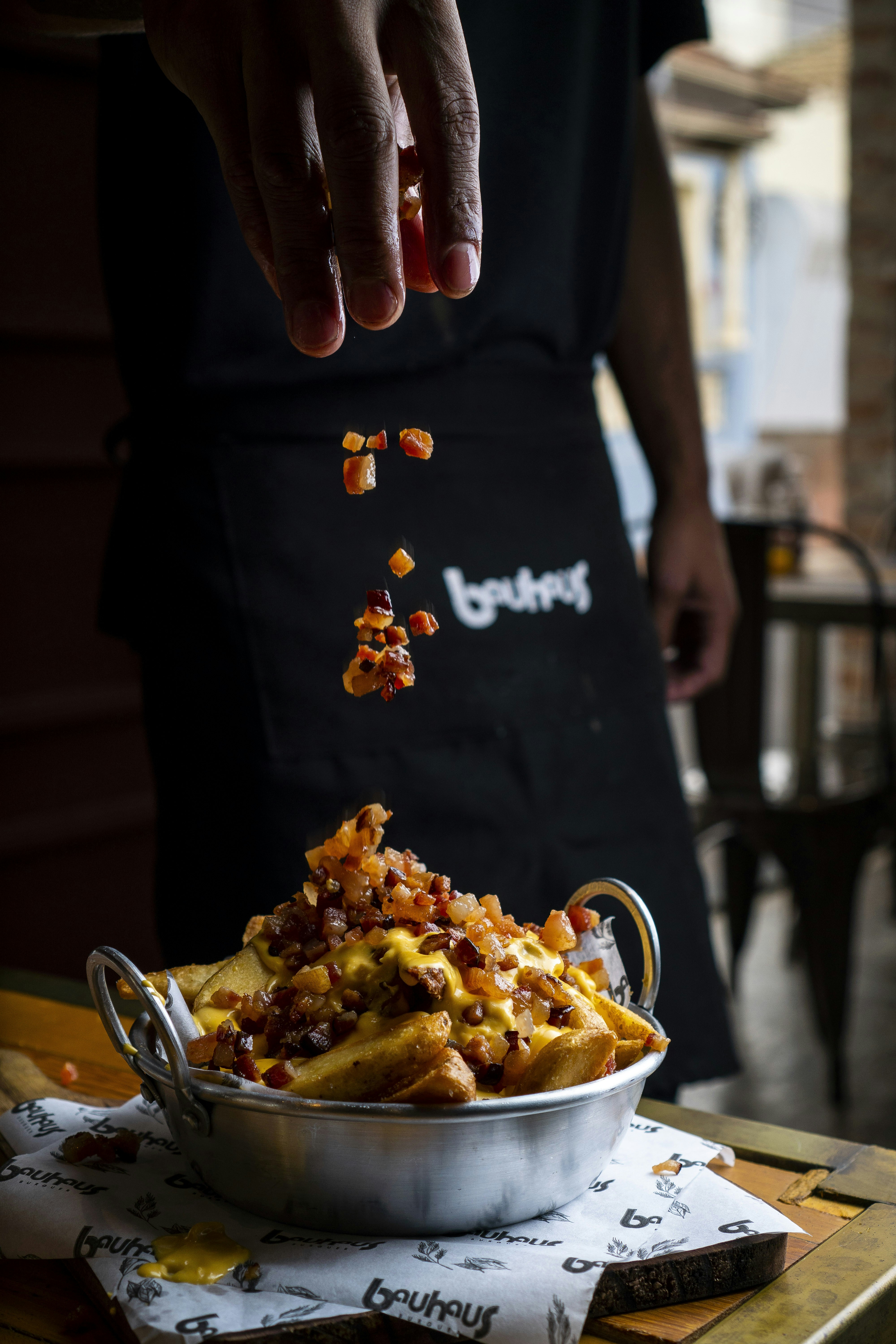 Falling Cheddar Sparks: Crispy Topping Drops Onto a Pot of Loaded Potatoes
