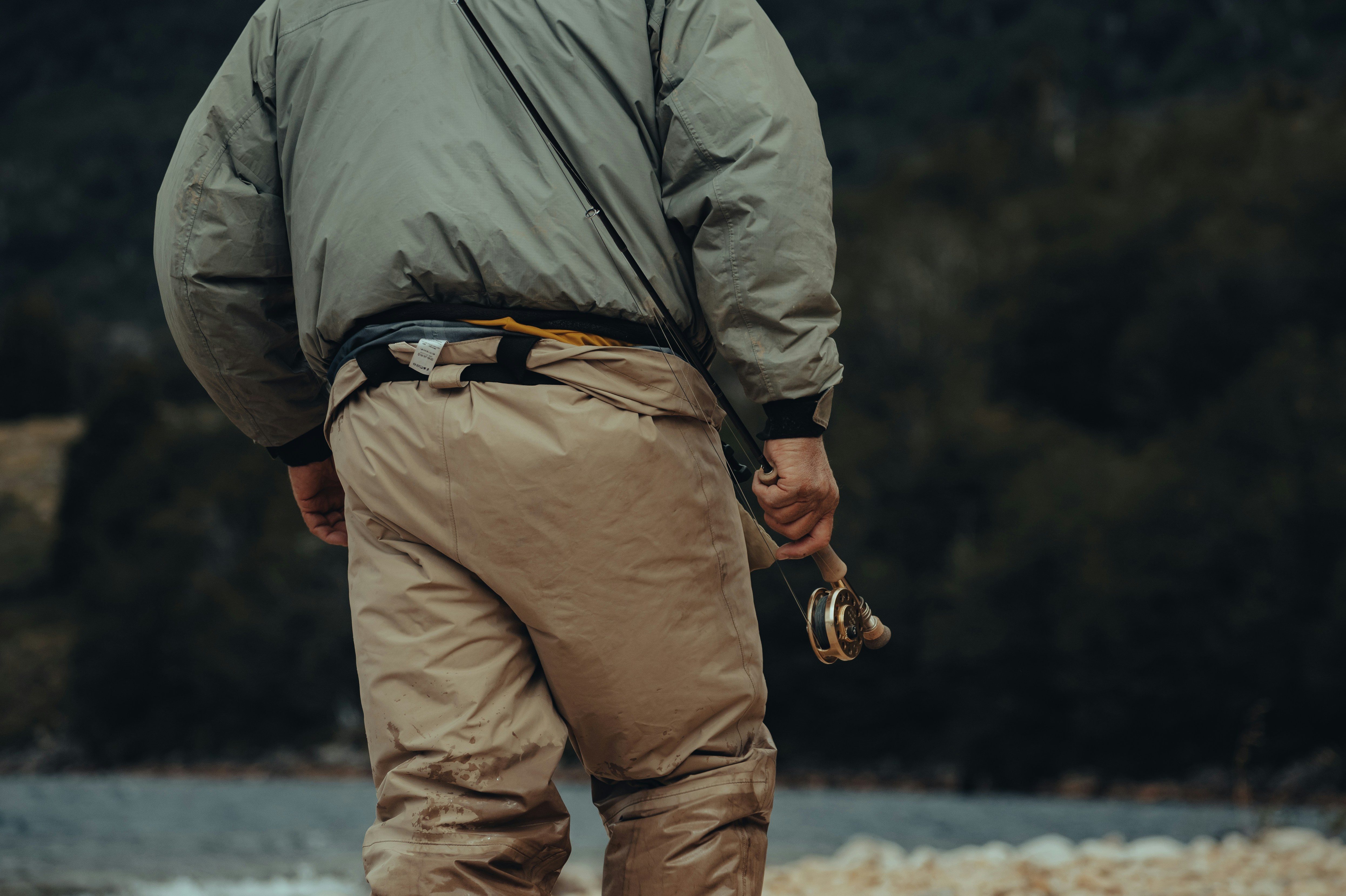 A man walking with a fishing rod in his hand photo – Free Apparel Image ...