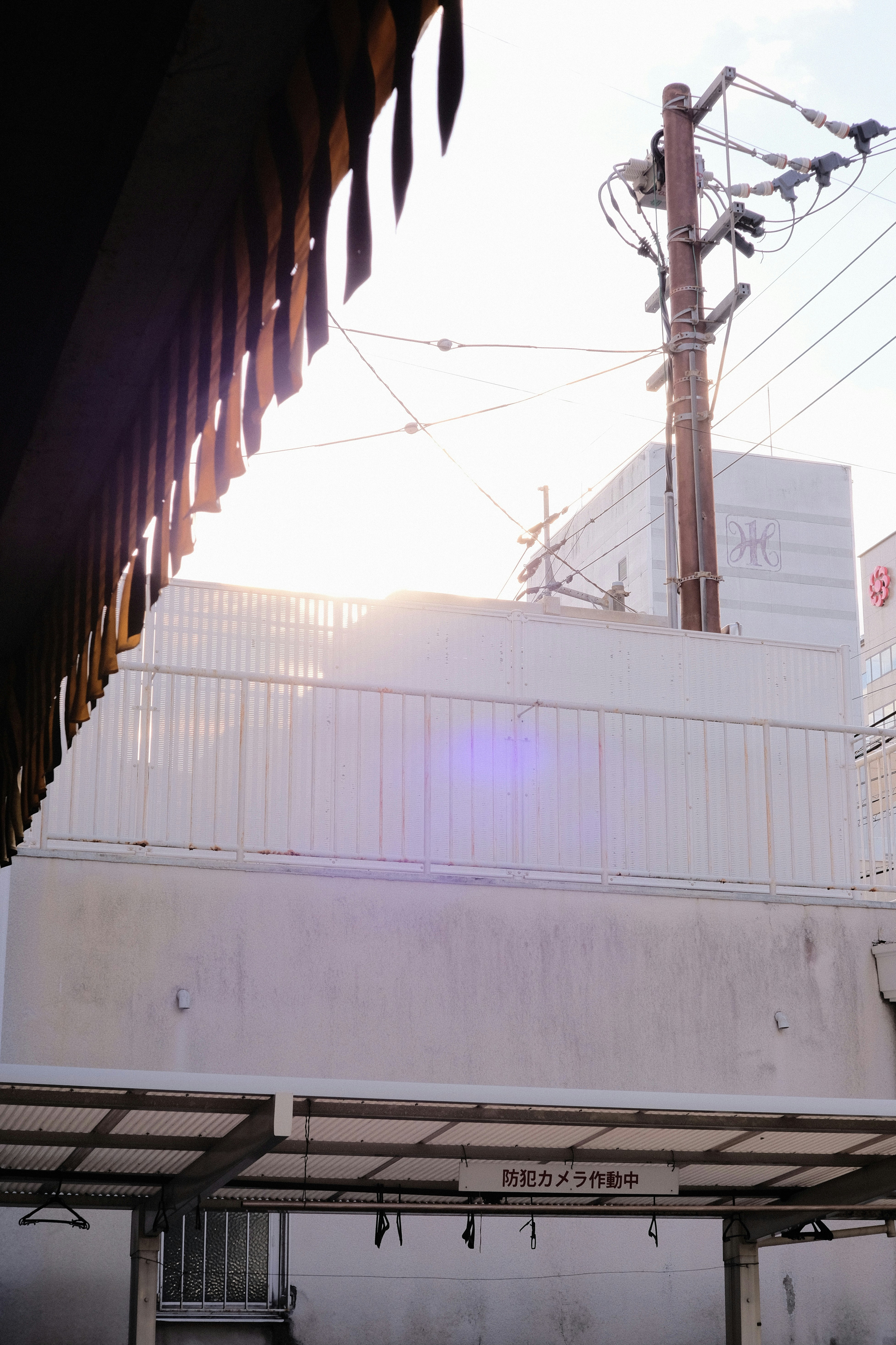A tall white building sitting under power lines photo – Free Grey Image ...