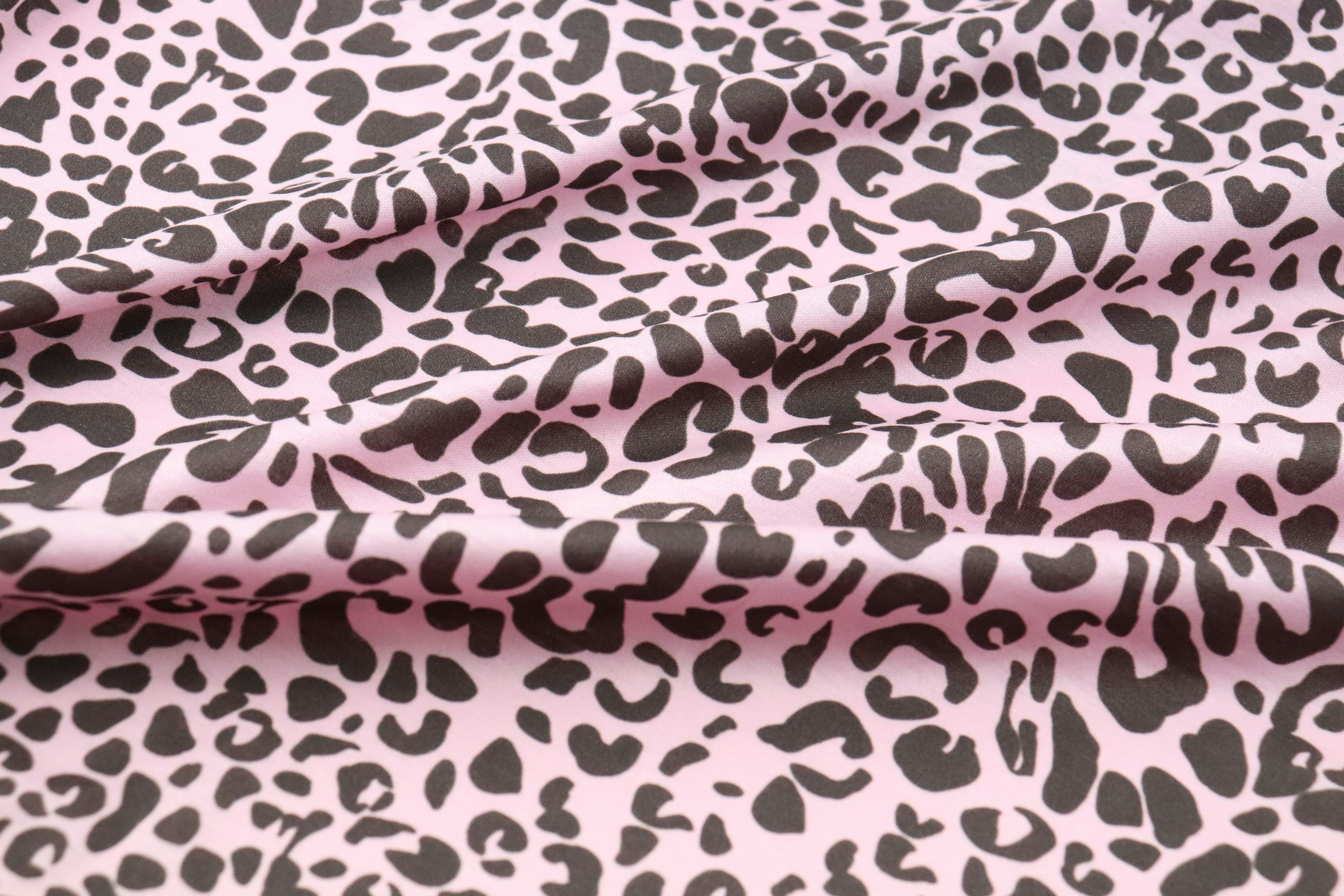 Draped Pink Leopard Print Fabric: Soft Waves and Shadowed Texture