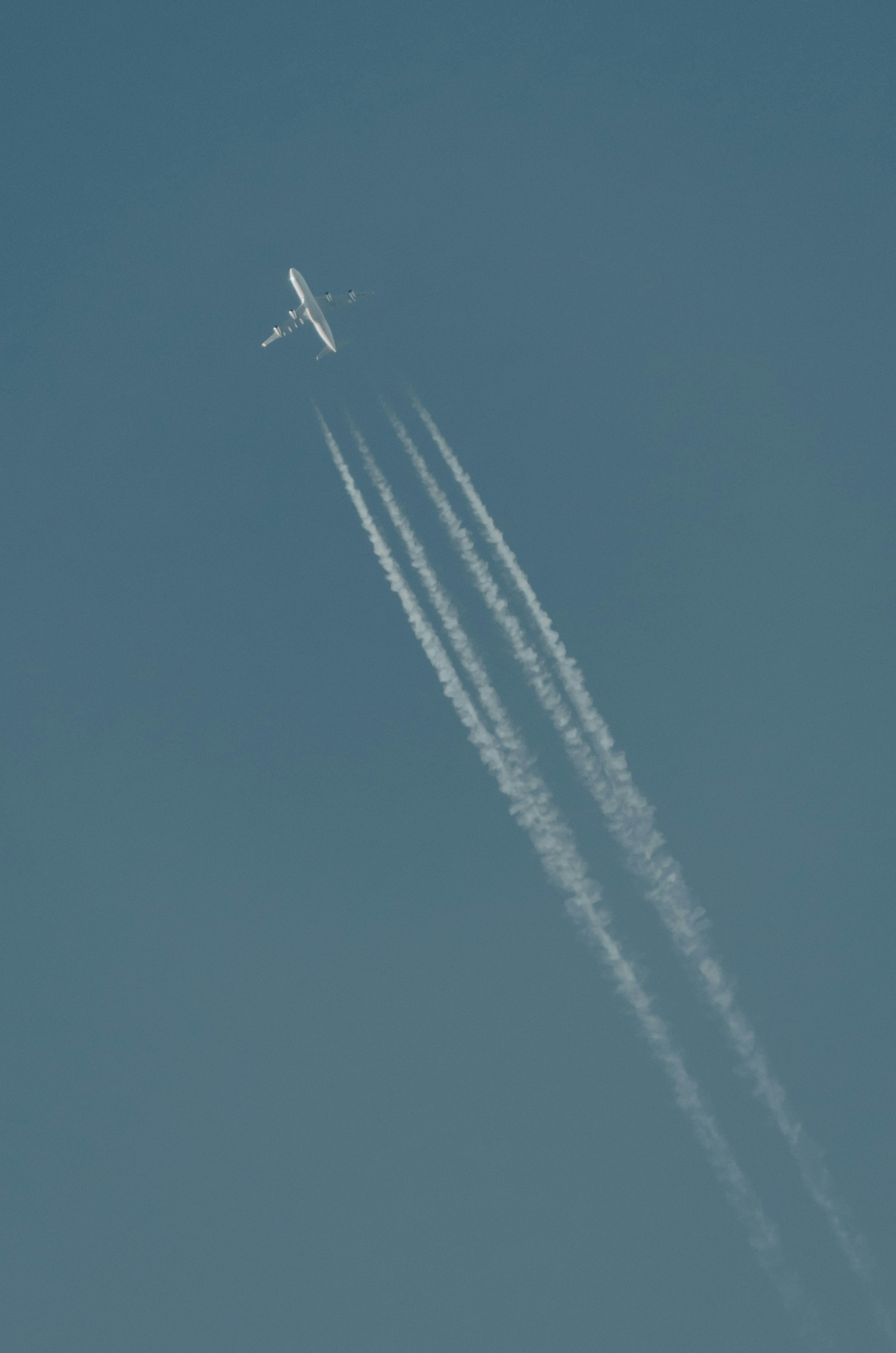 An airplane flying in the sky leaving a trail of smoke behind it photo ...