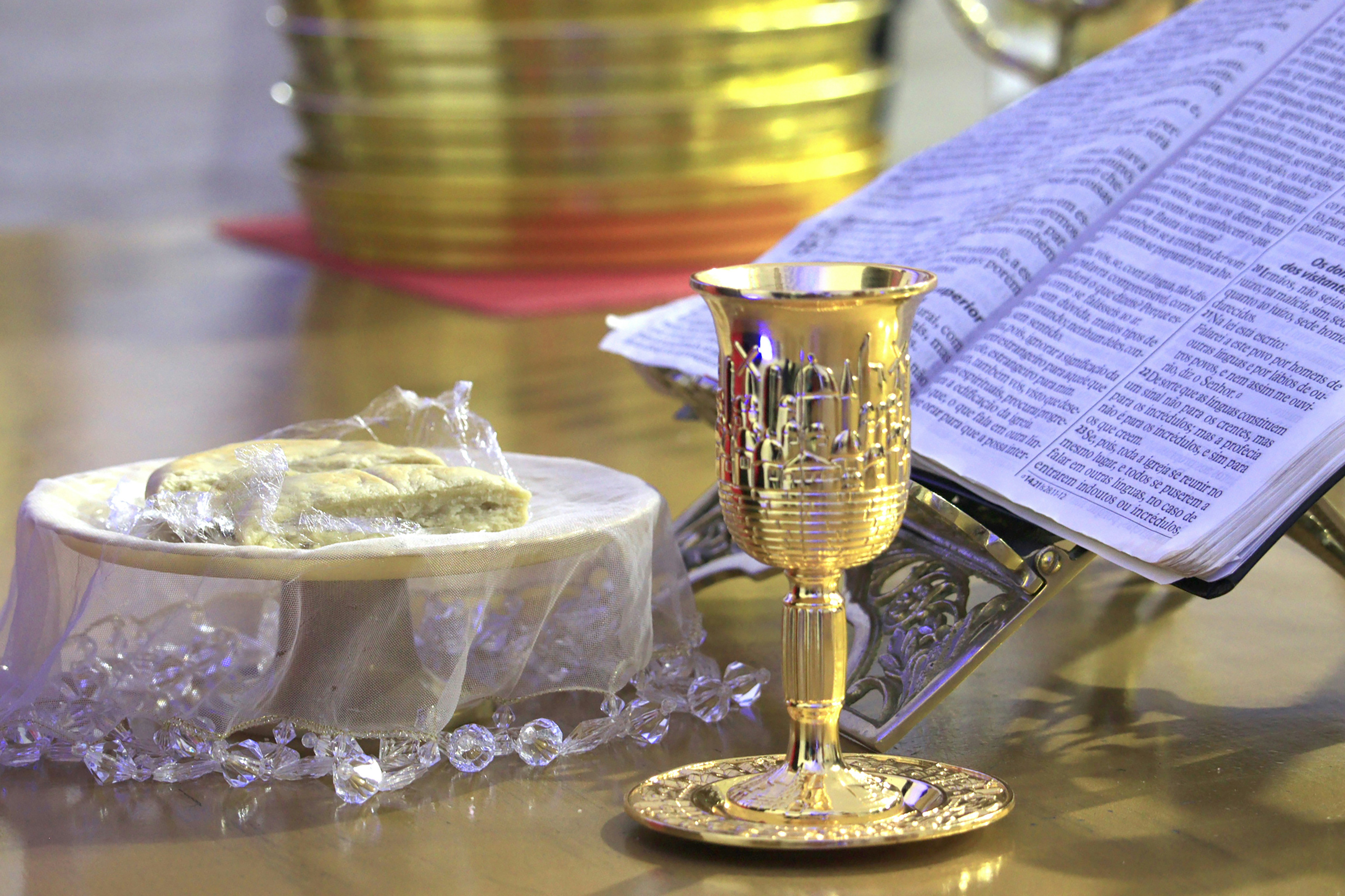 Gilded Chalice Amid Ice Crystals and Open Scripture