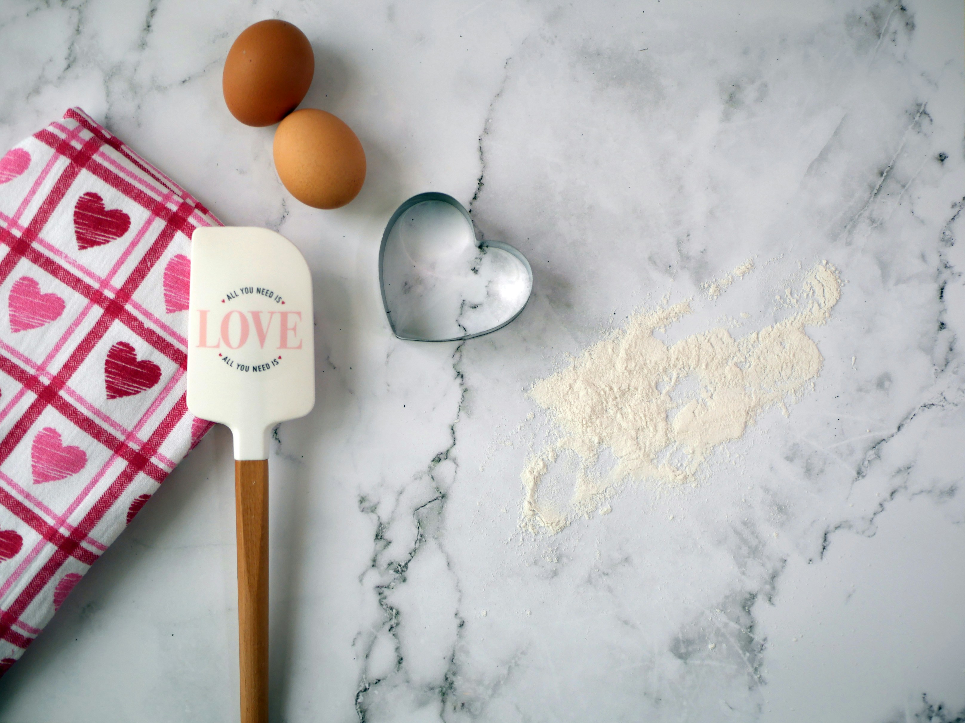 A kitchen counter with a spatula, eggs and flour on it photo – Free ...