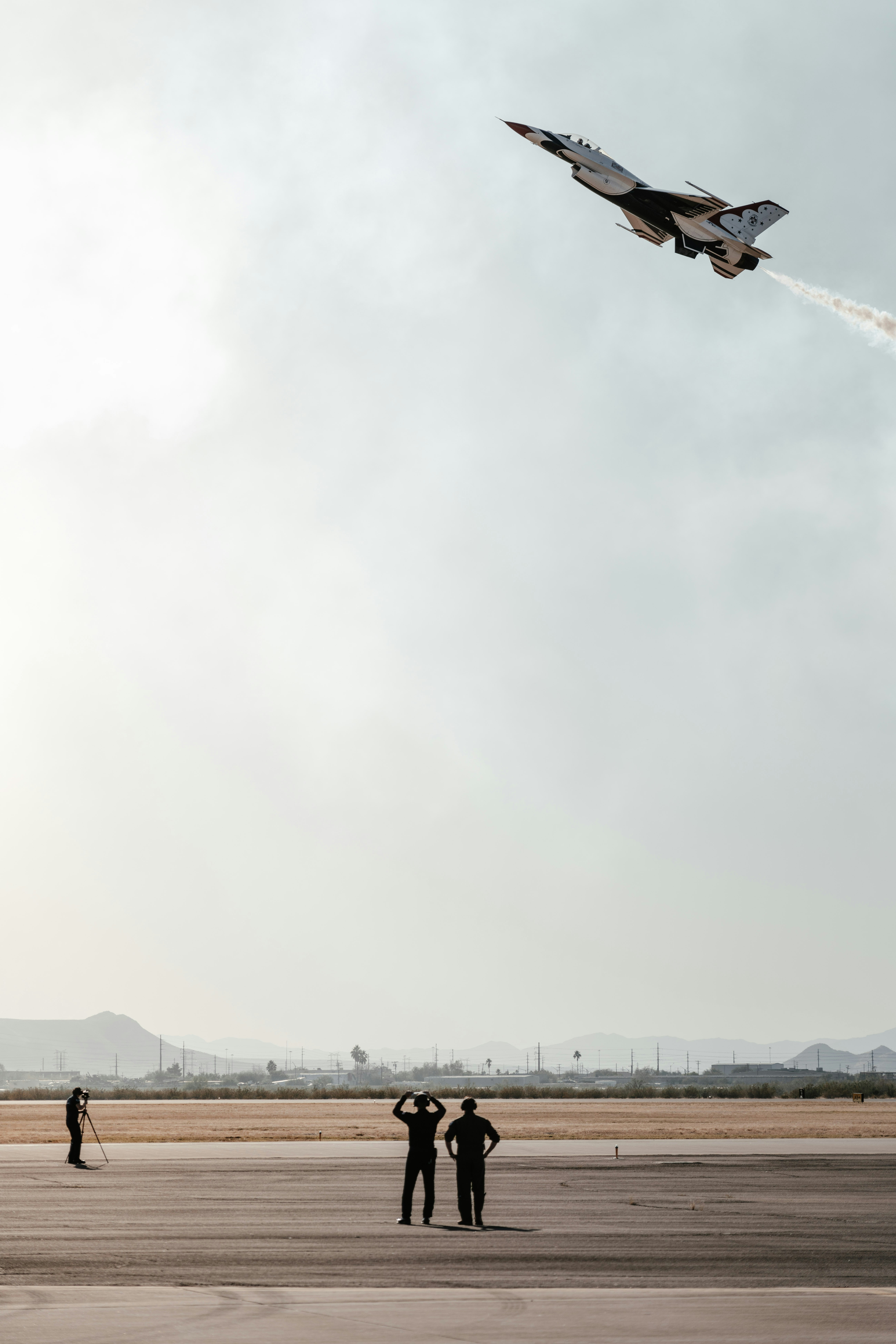 Two people watching a fighter jet fly in the sky photo – Free Grey ...
