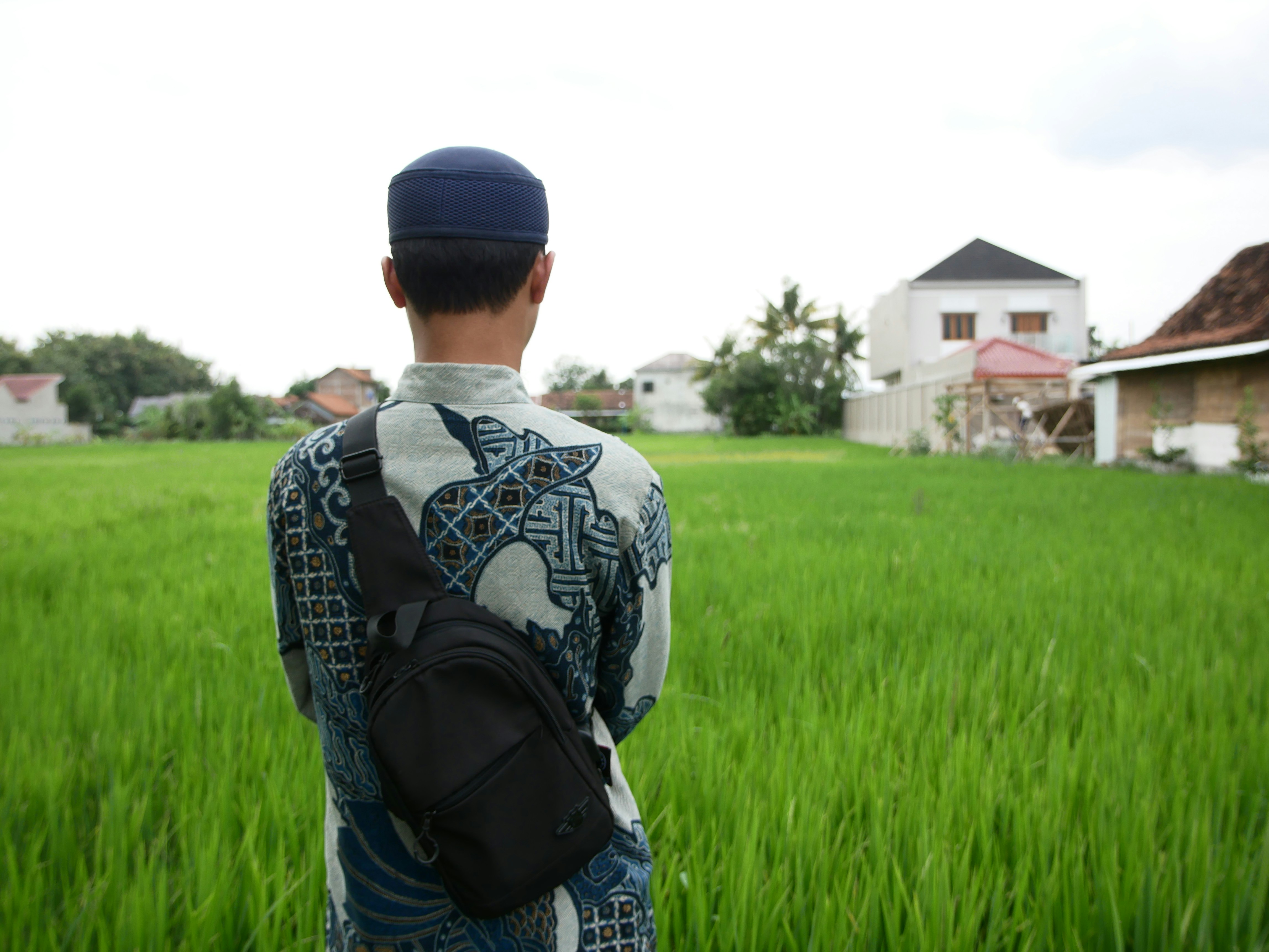 A man standing in a field of green grass photo – Free Masjid ...