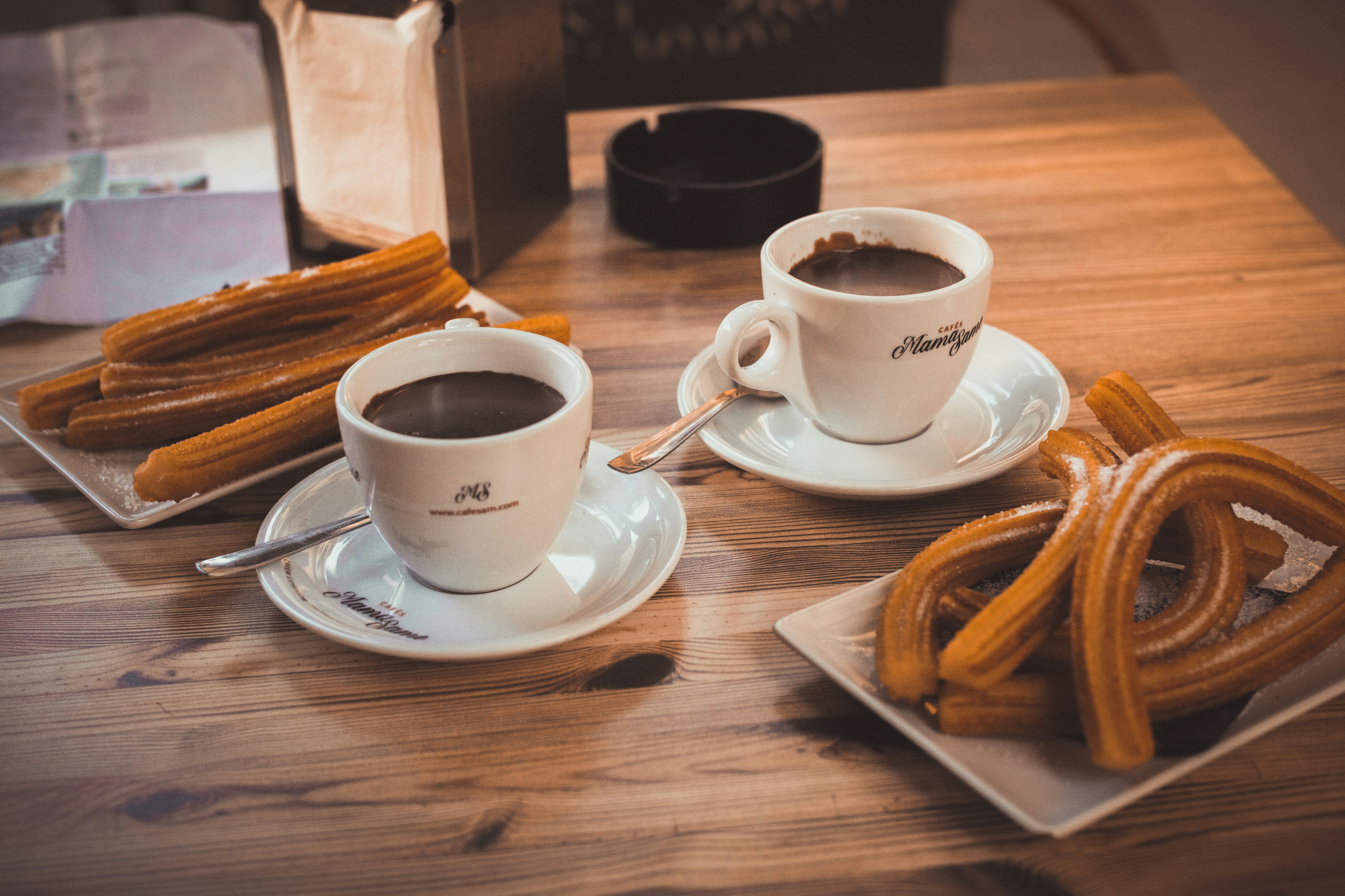Two cups of coffee and some churros on a table photo – Free #spain ...