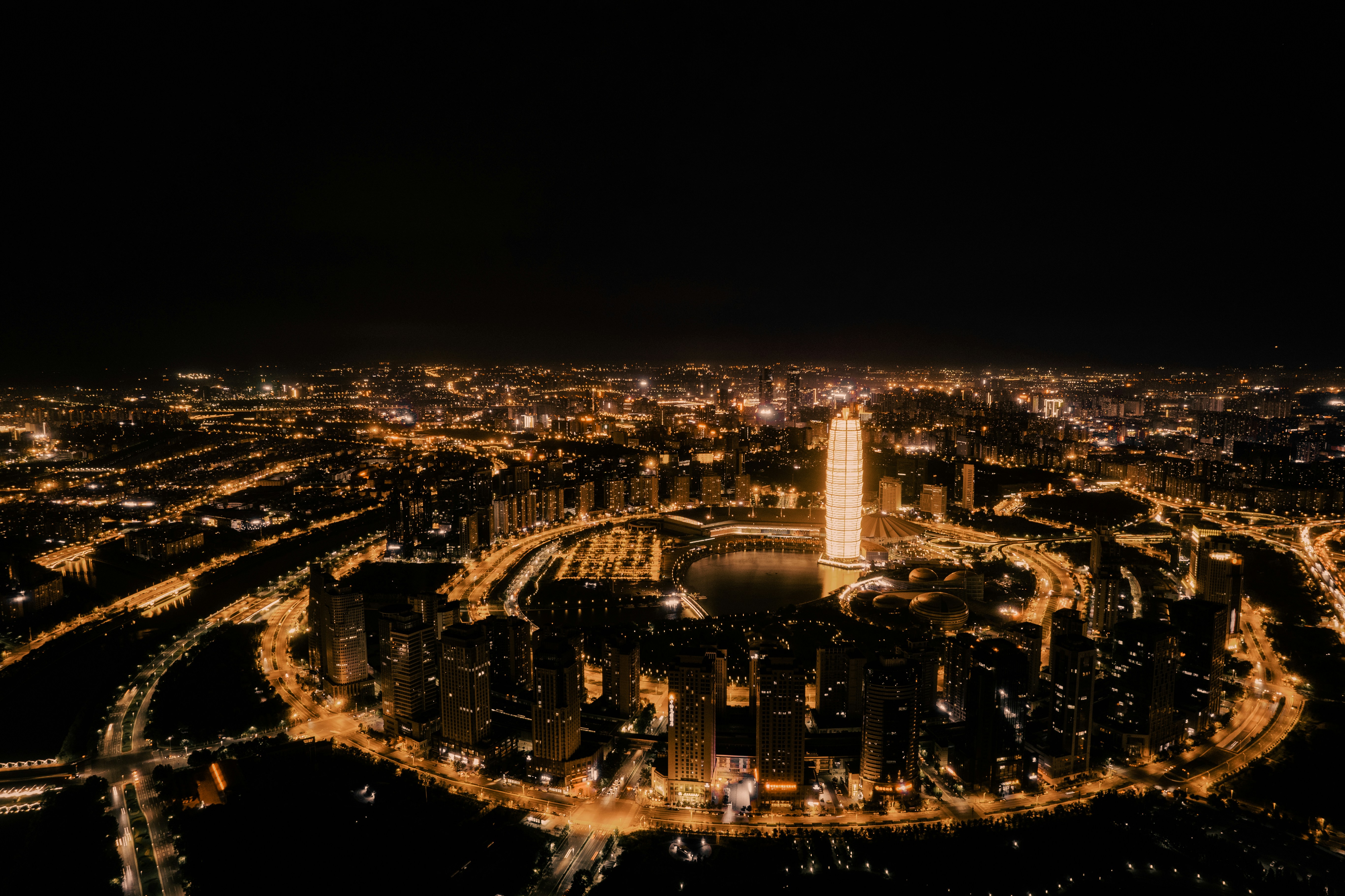 Ring City at Night: Aerial Portrait of a Luminous Central Tower