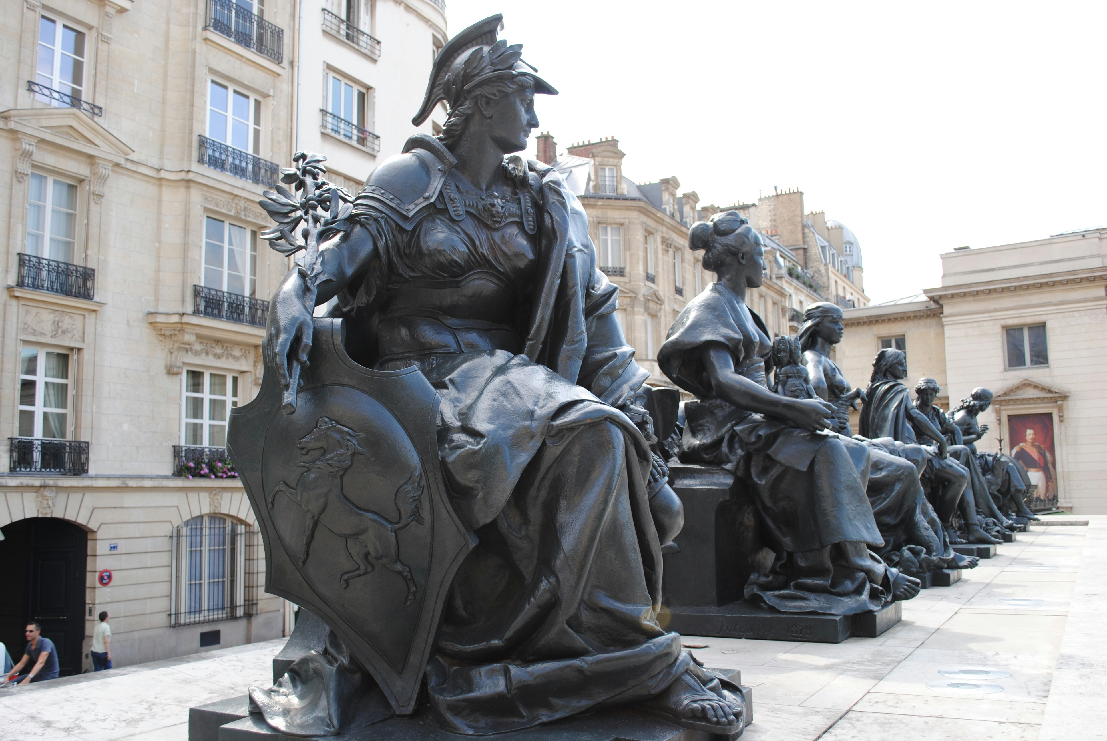 Guardians of the Plaza: A Row of Bronze Figures on a City Stair