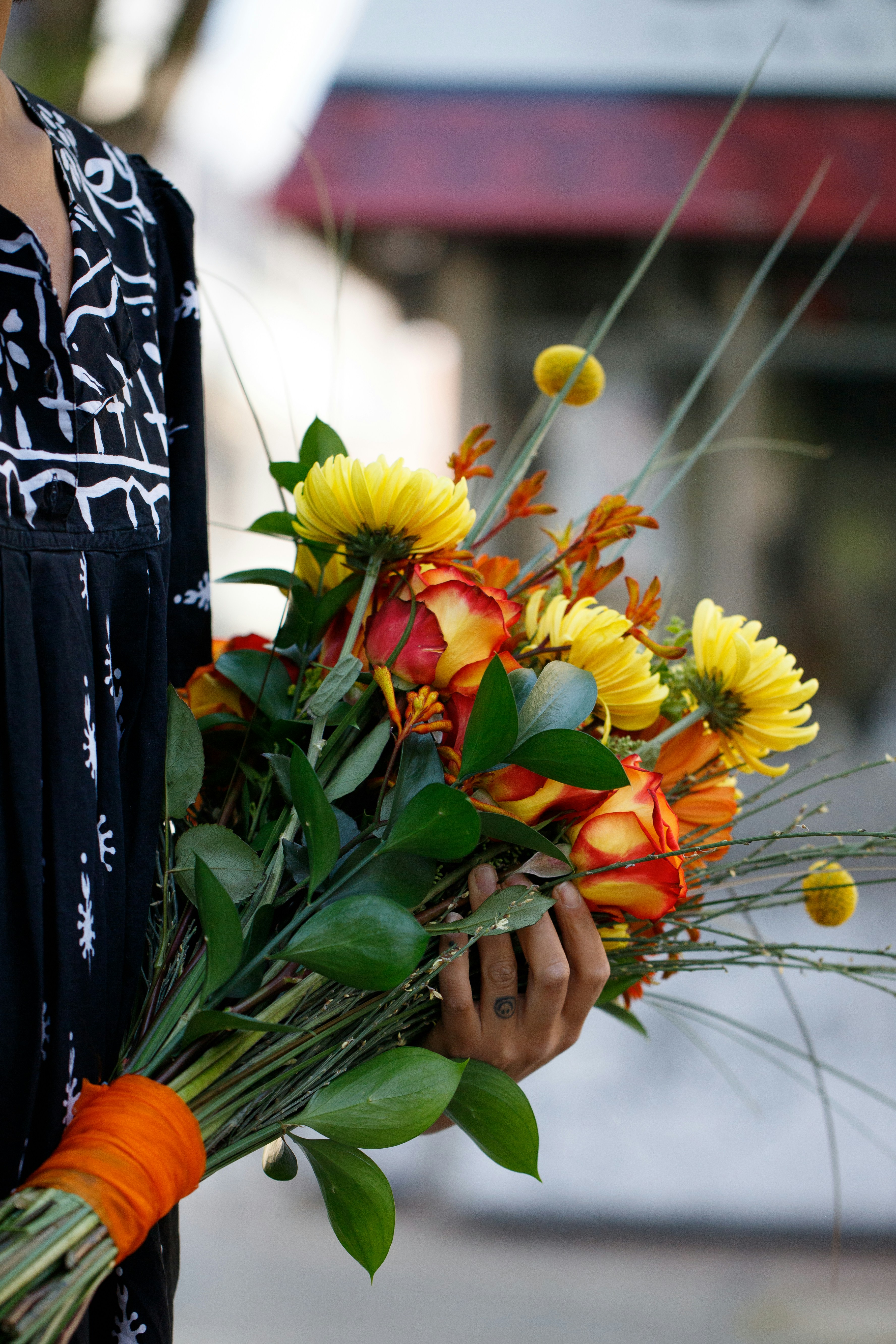 Bouquet of Sunrise: A Handful of Orange Roses and Yellow Blooms