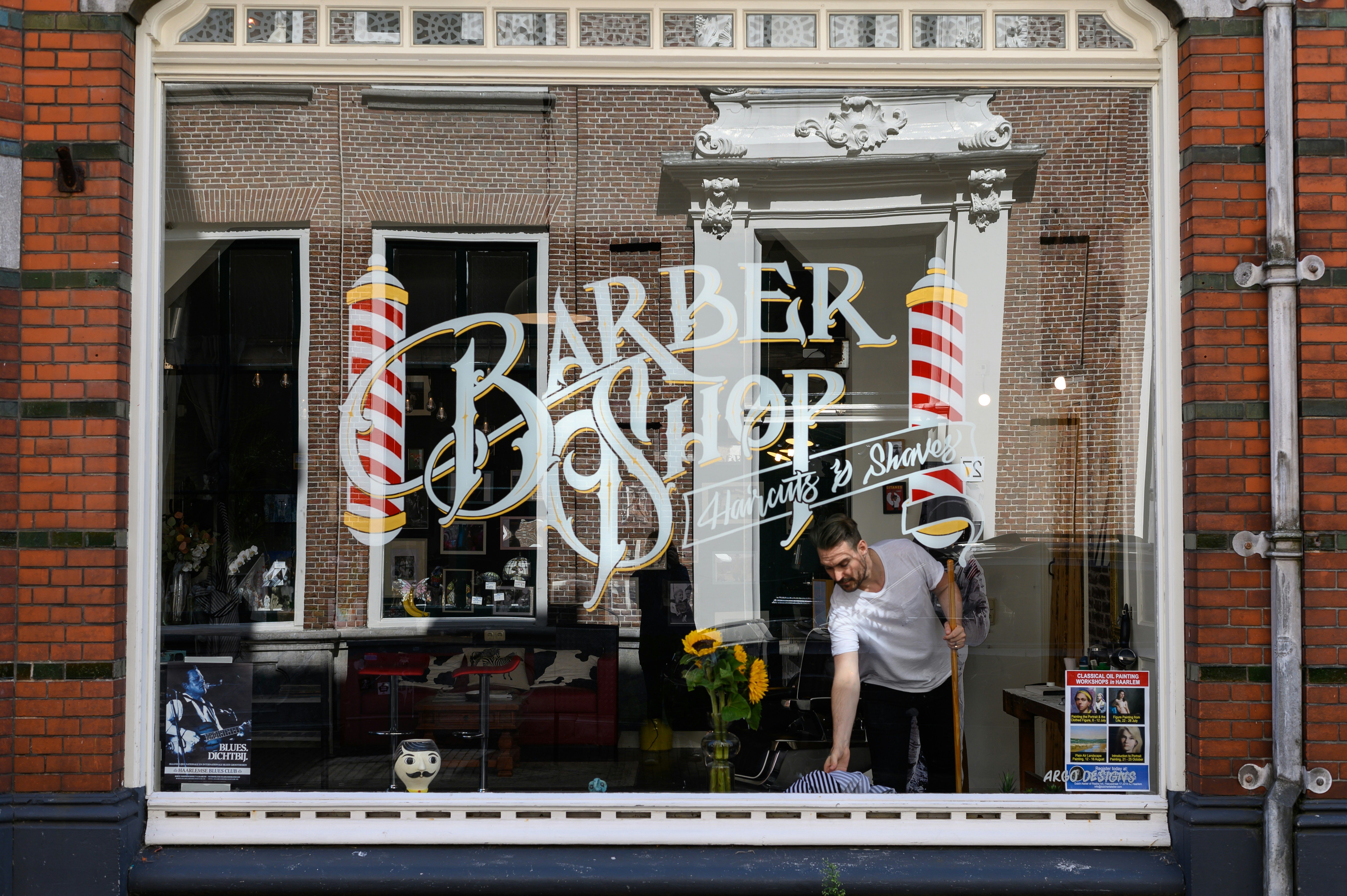 A man standing in front of a barber shop window photo – Free Window ...