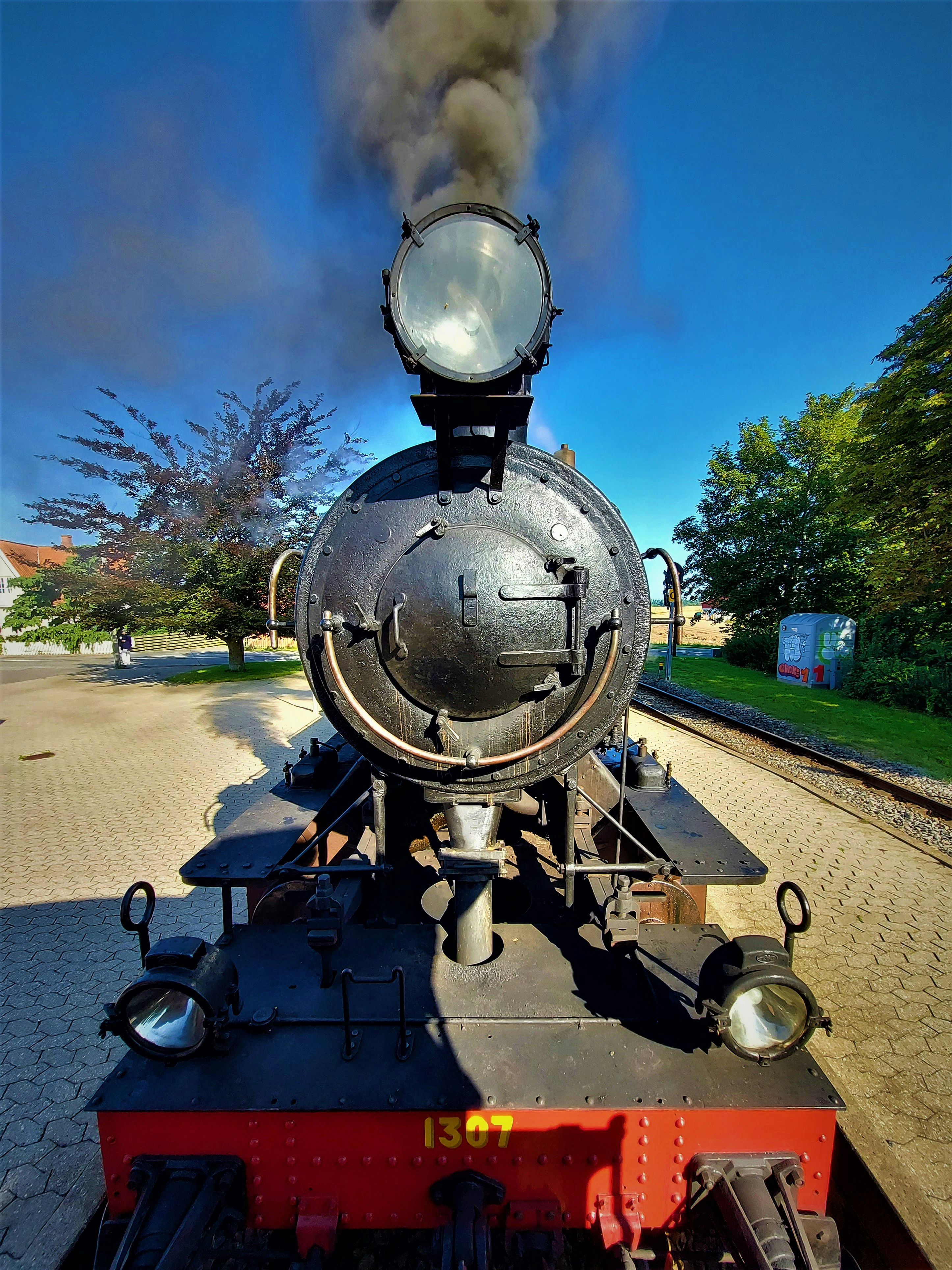 a steam engine train traveling down train tracks