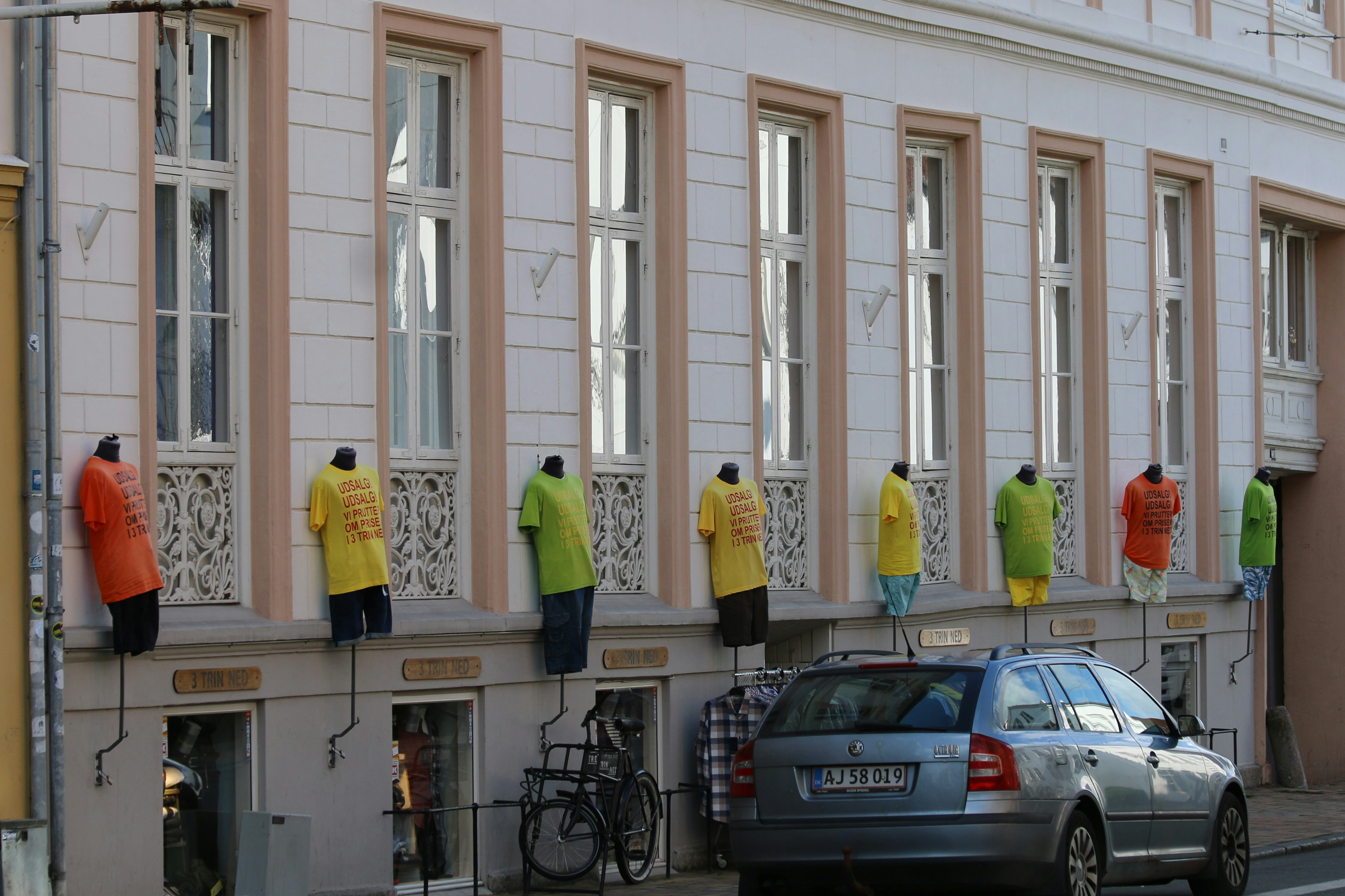 Colorful Lab Coats Line the Facade: A Quiet Street Scene
