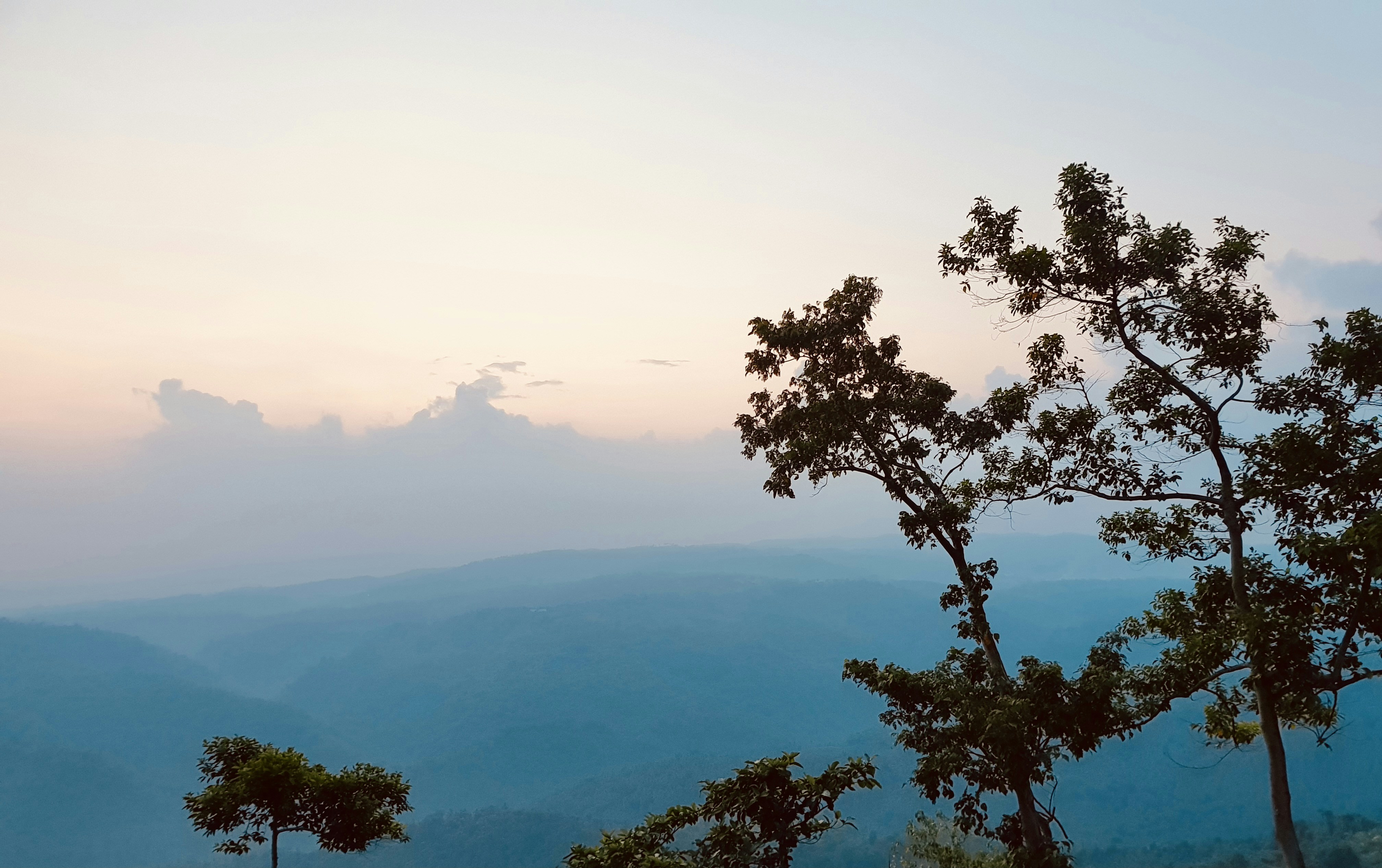 Dawn's Embrace Over Misty Hills
