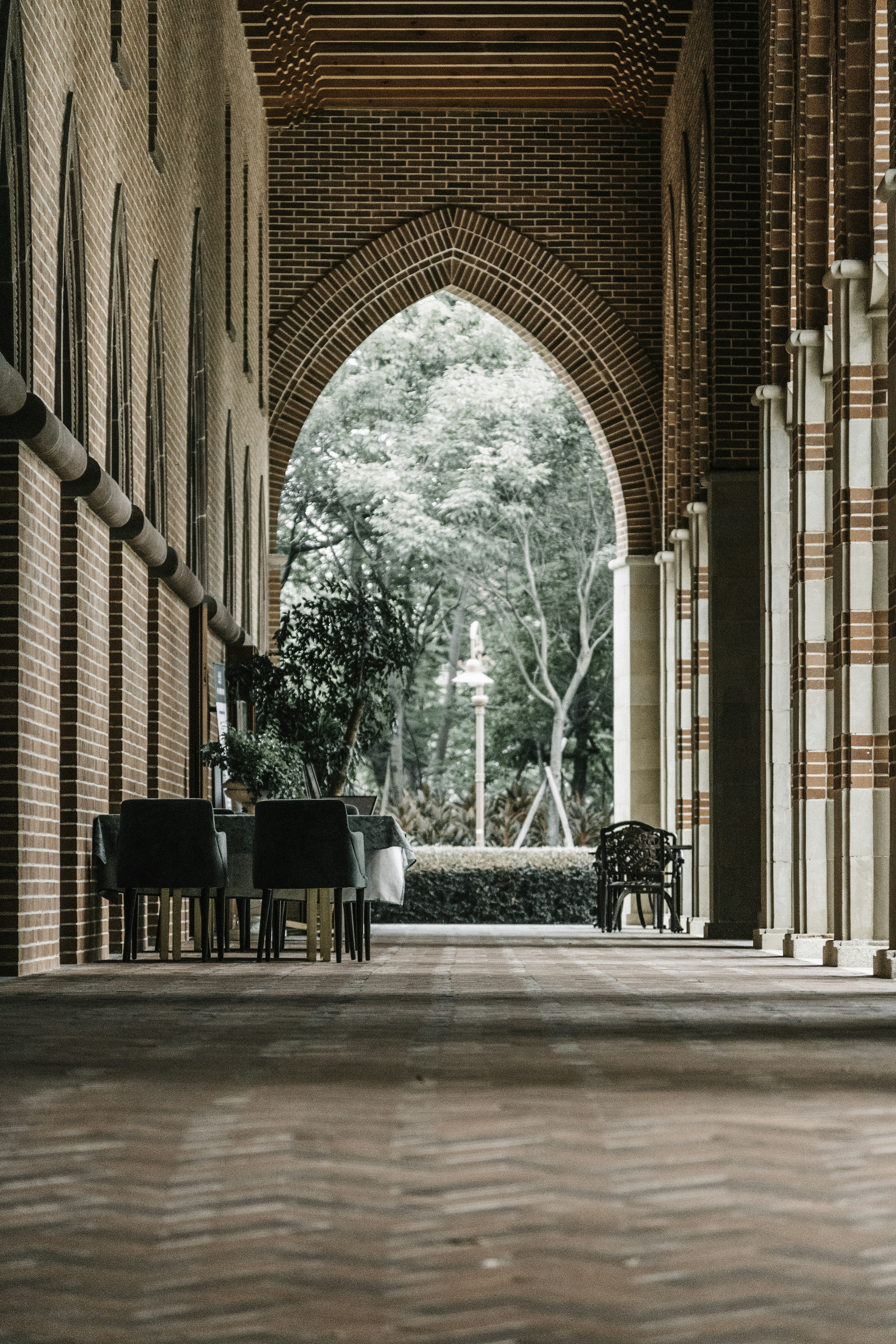 Symmetrical Brick Arcade: Archway Framing a Quiet Garden View