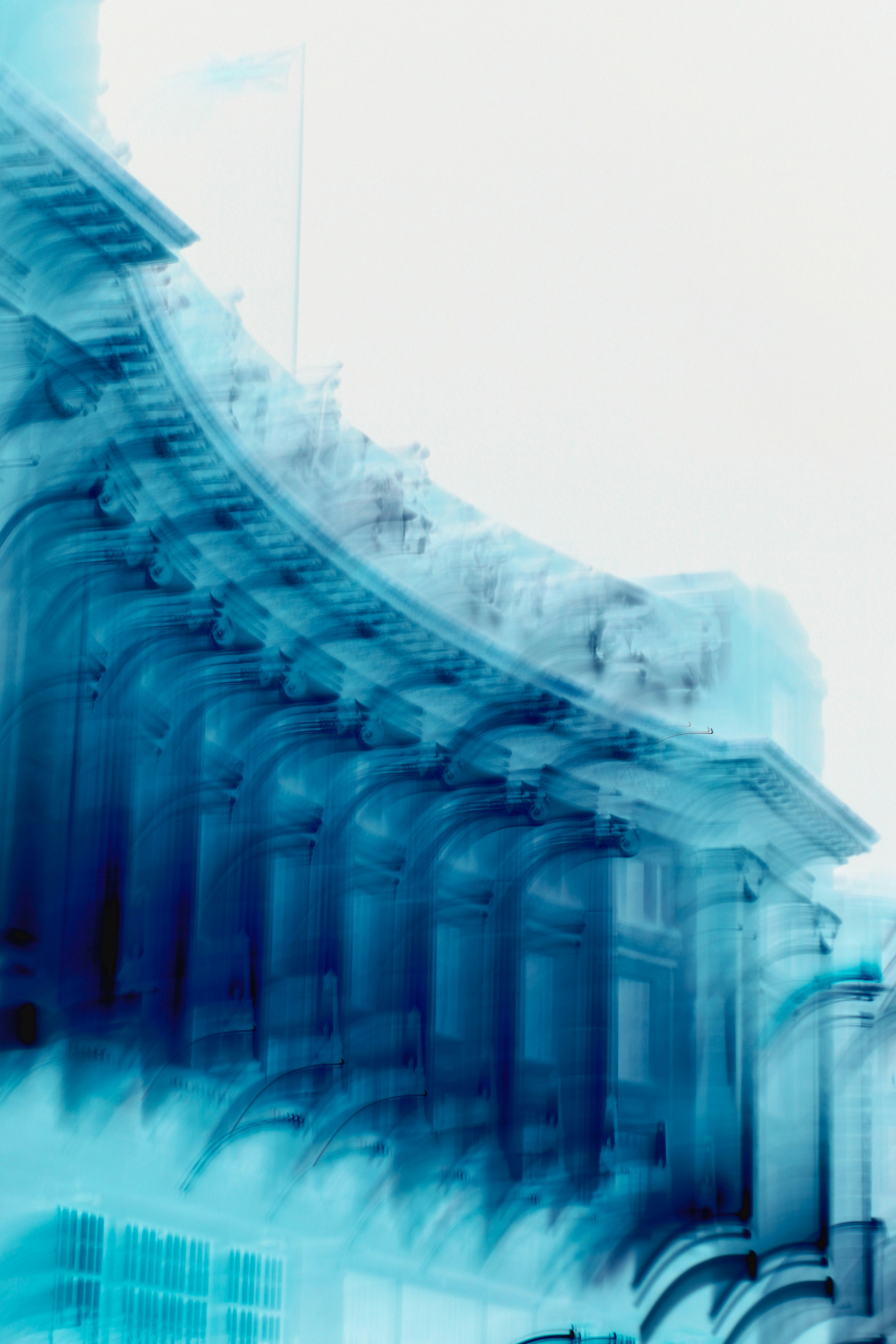 A blurry photo of a building with a clock tower photo – Free Phone ...