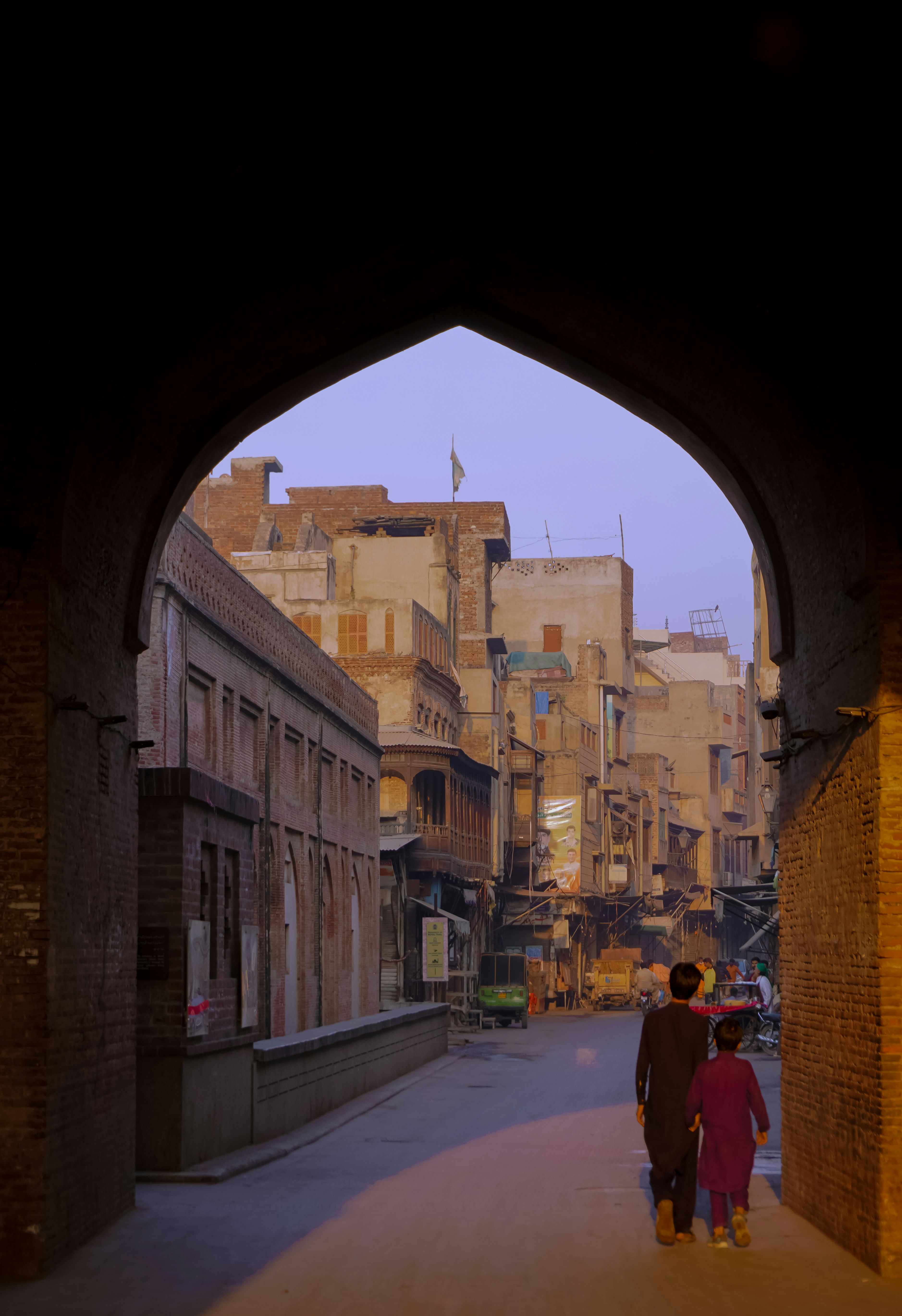 Archway Twilight: A Quiet Bazaar Street Bathed in Clay and Purple Light