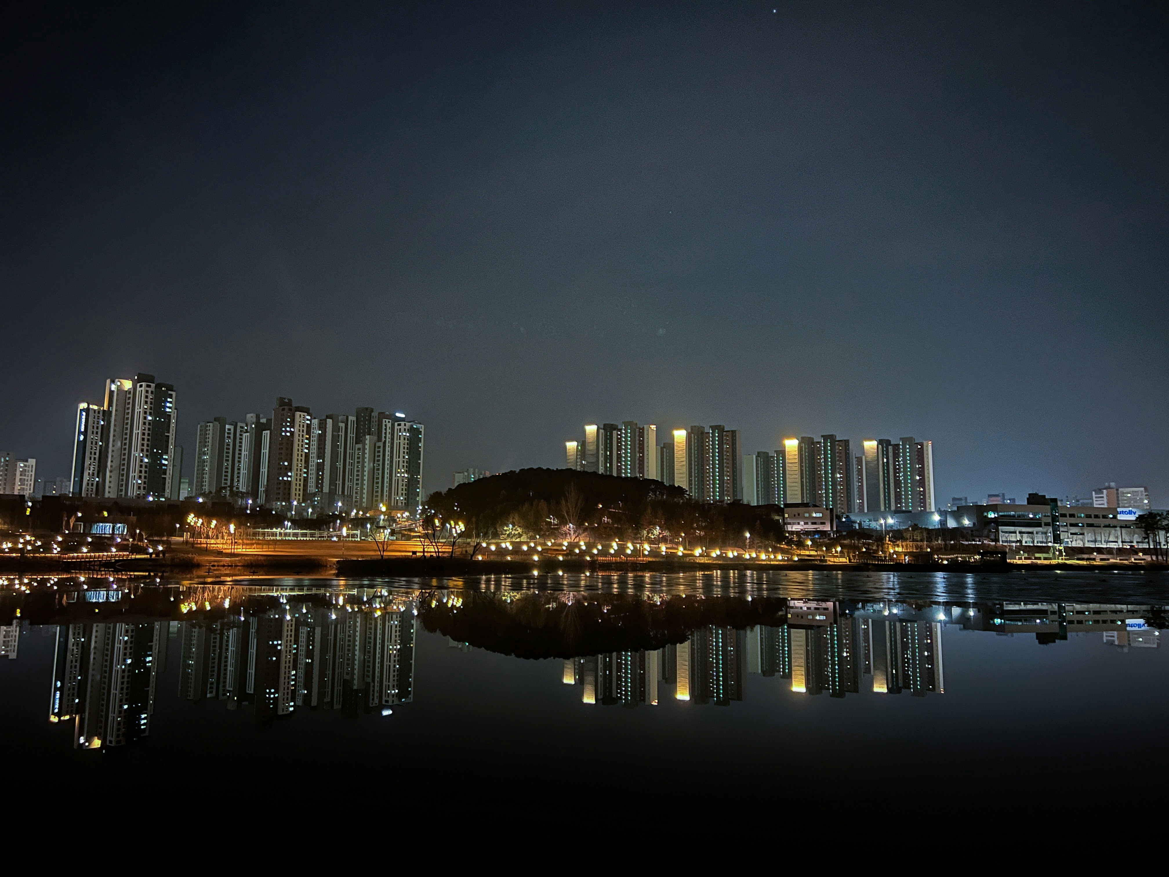 City Reflections: Nighttime skyline mirrored on calm waters
