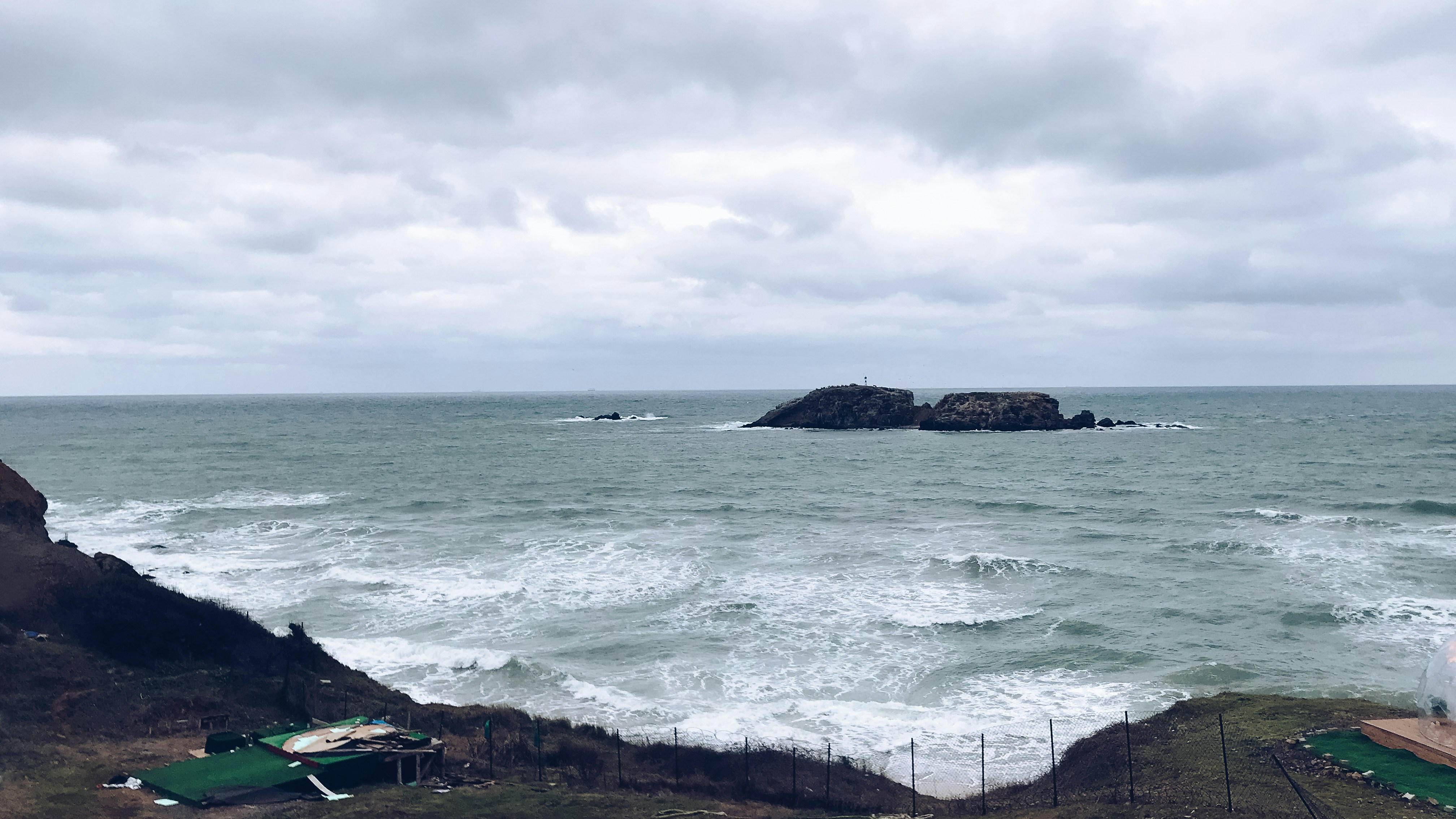 Cloudy sky over a rocky coastline with choppy sea waves near Istanbul.