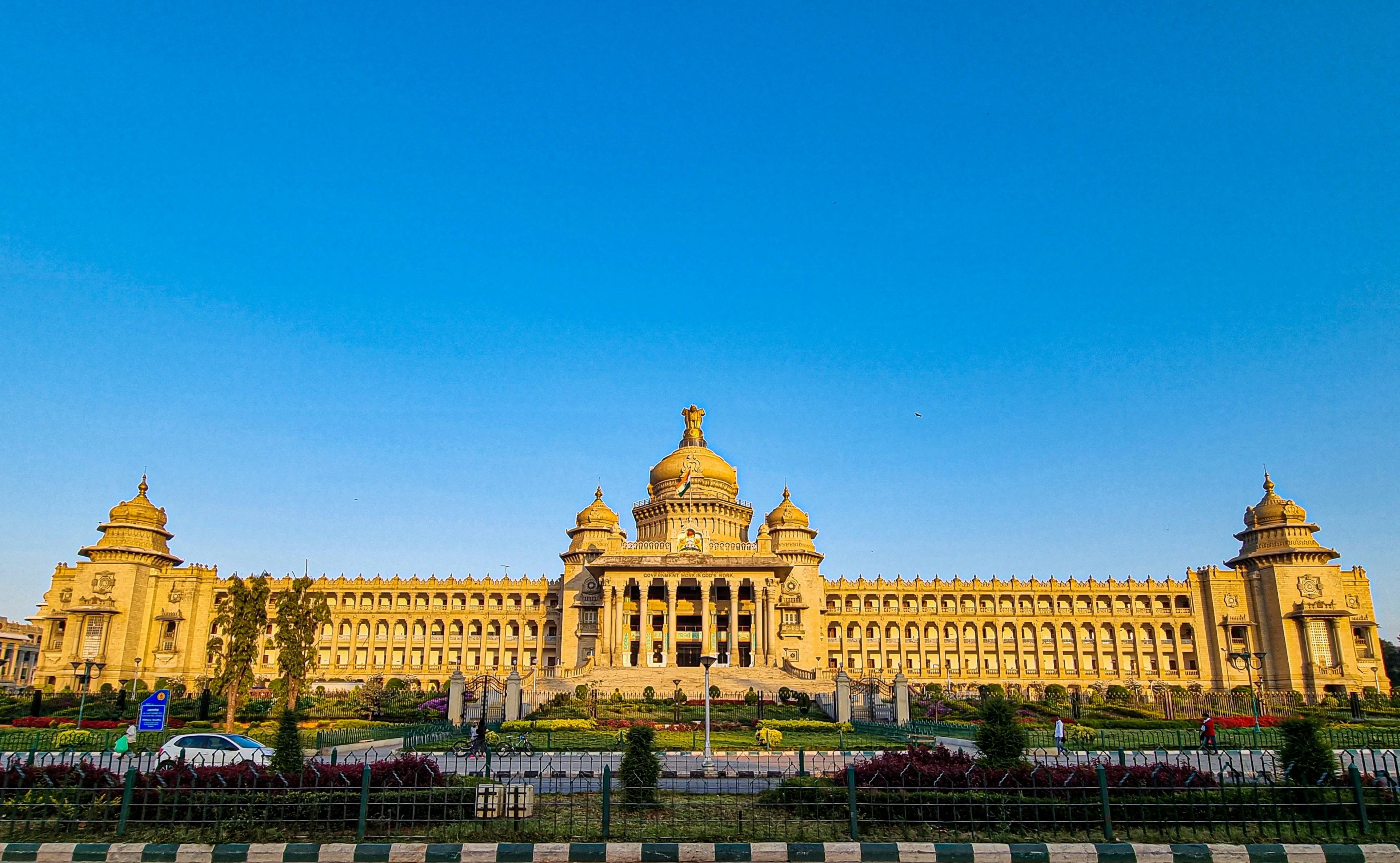 Imperial Courtyard: A Symmetrical Gold Facade Under a Clear Blue Sky
