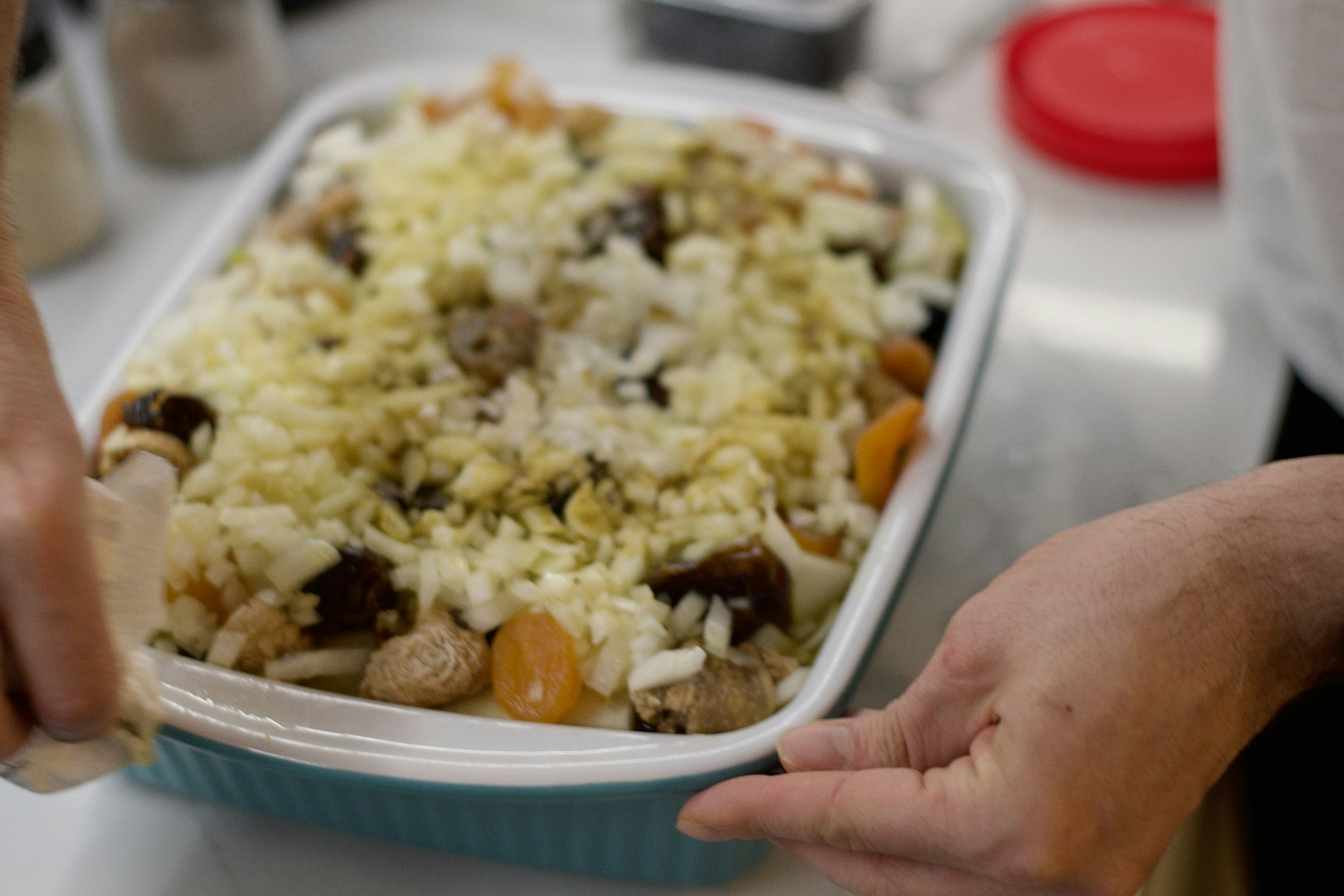 A close up of a person putting food in a container photo – Free Food ...