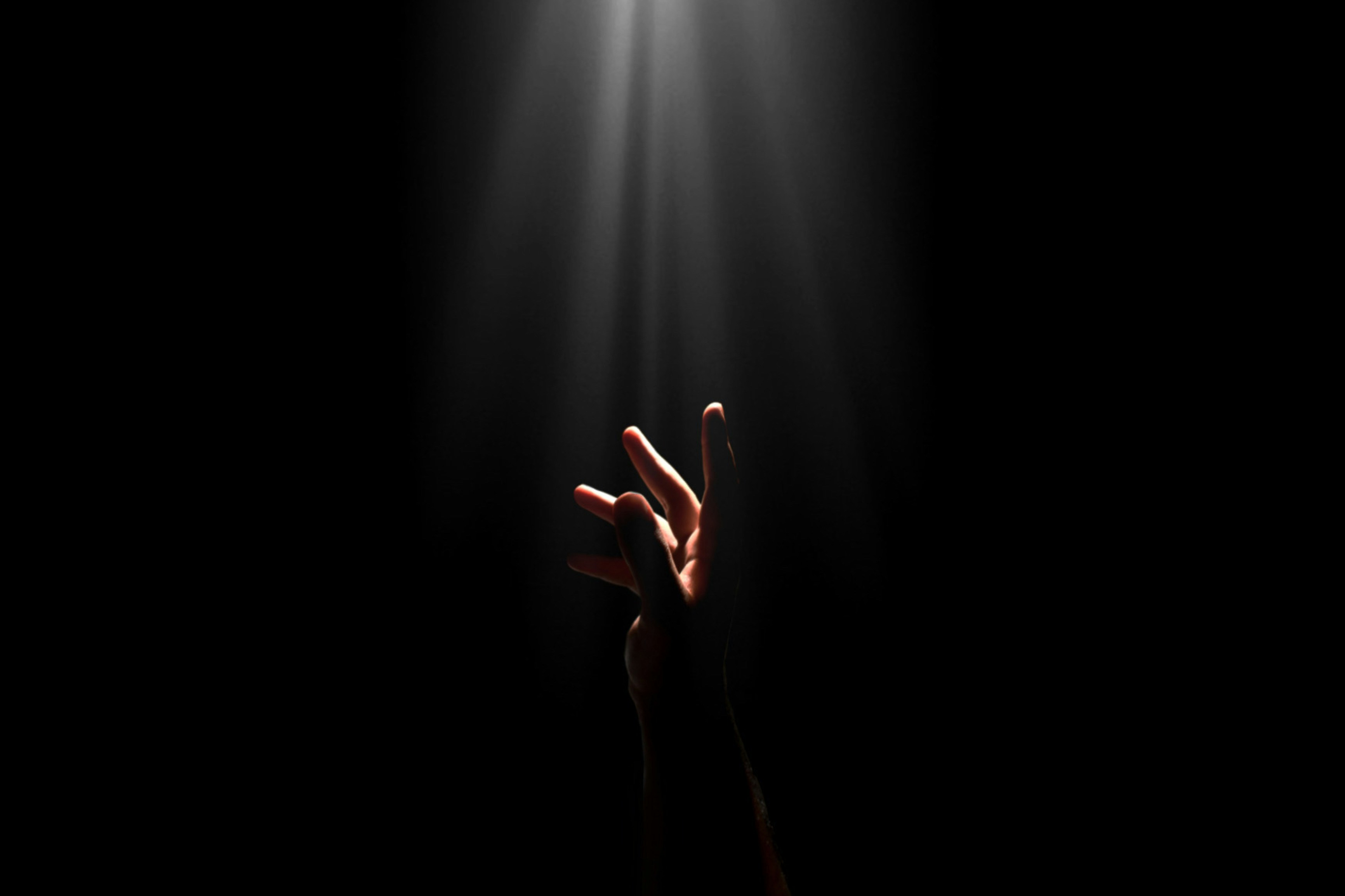 A person's hand reaching up towards a light beam photo – Free Lighting ...