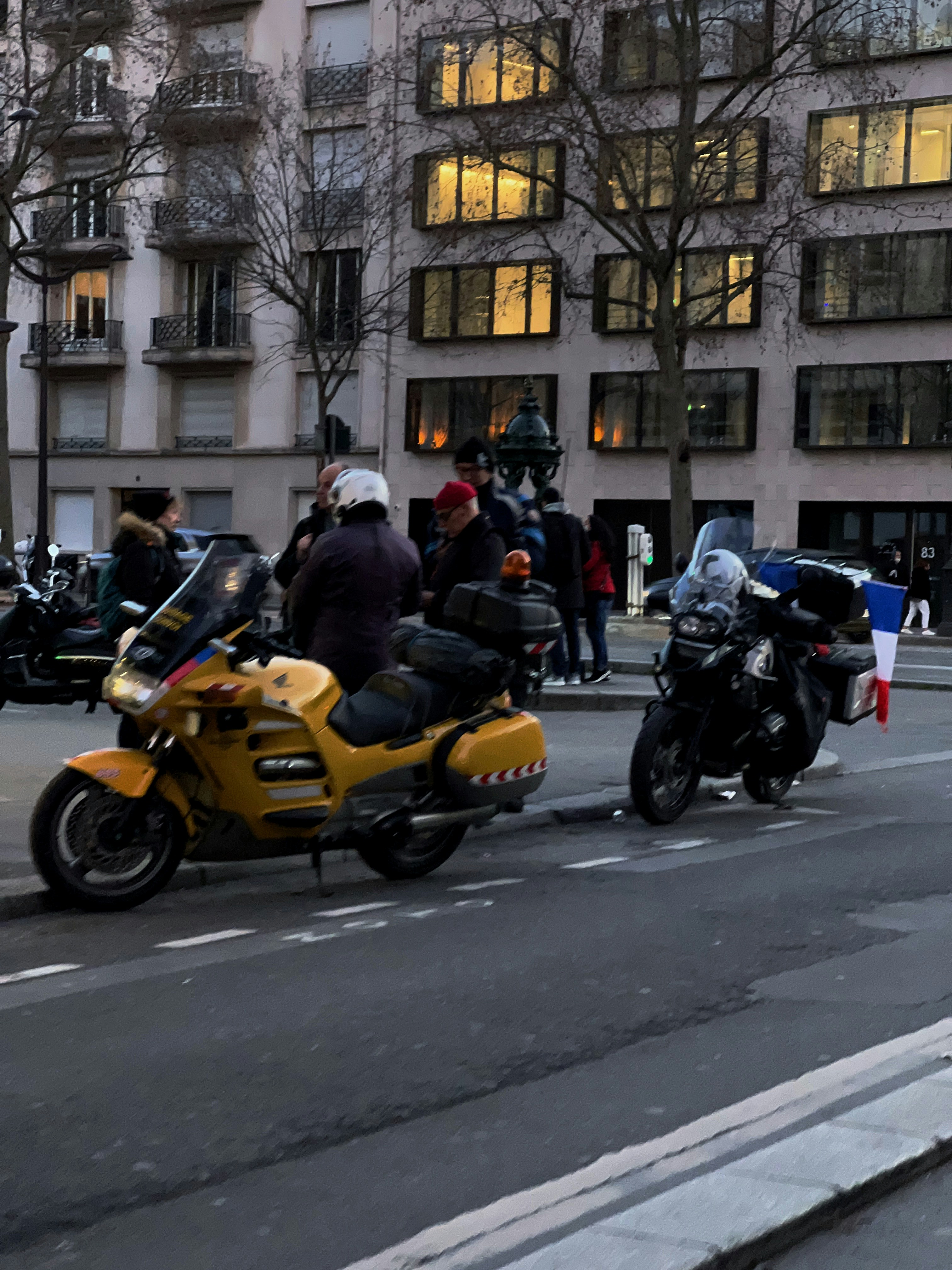Center-Stage Yellow Tourer Amid a Parisian Street Assembly