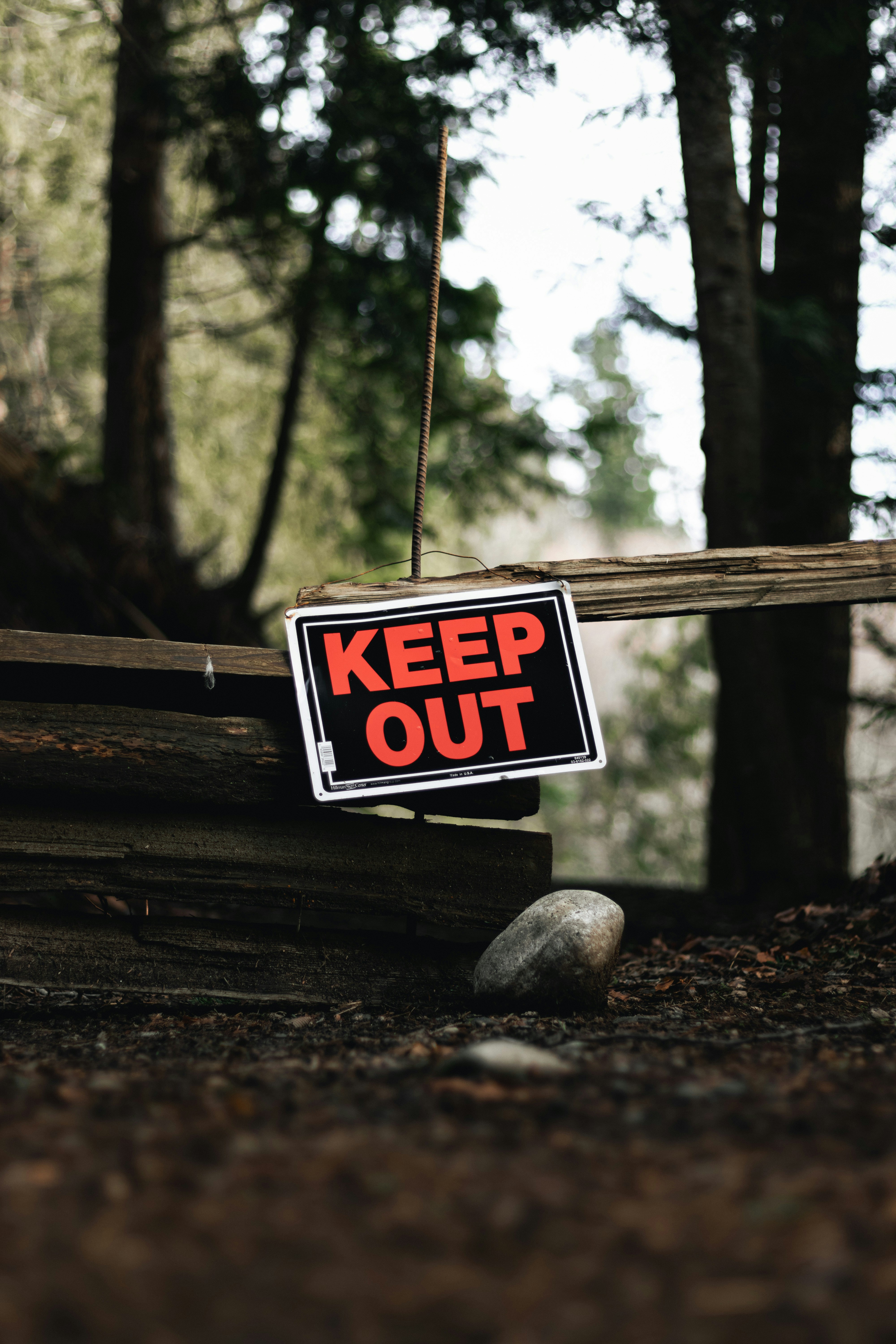A keep out sign hanging from a wooden fence photo – Free Tree Image on ...