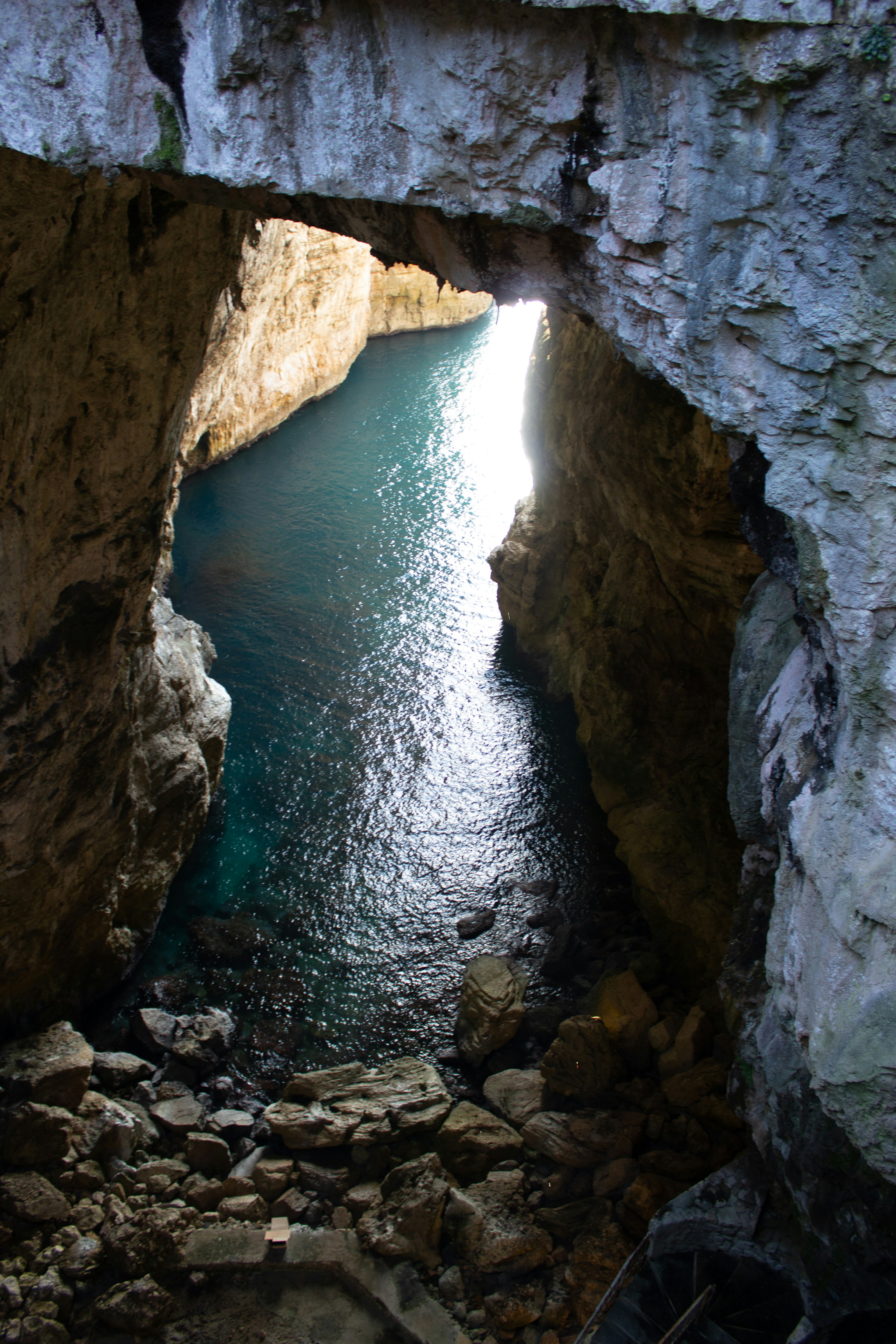 A cave with a body of water inside of it photo – Free Nature Image on ...
