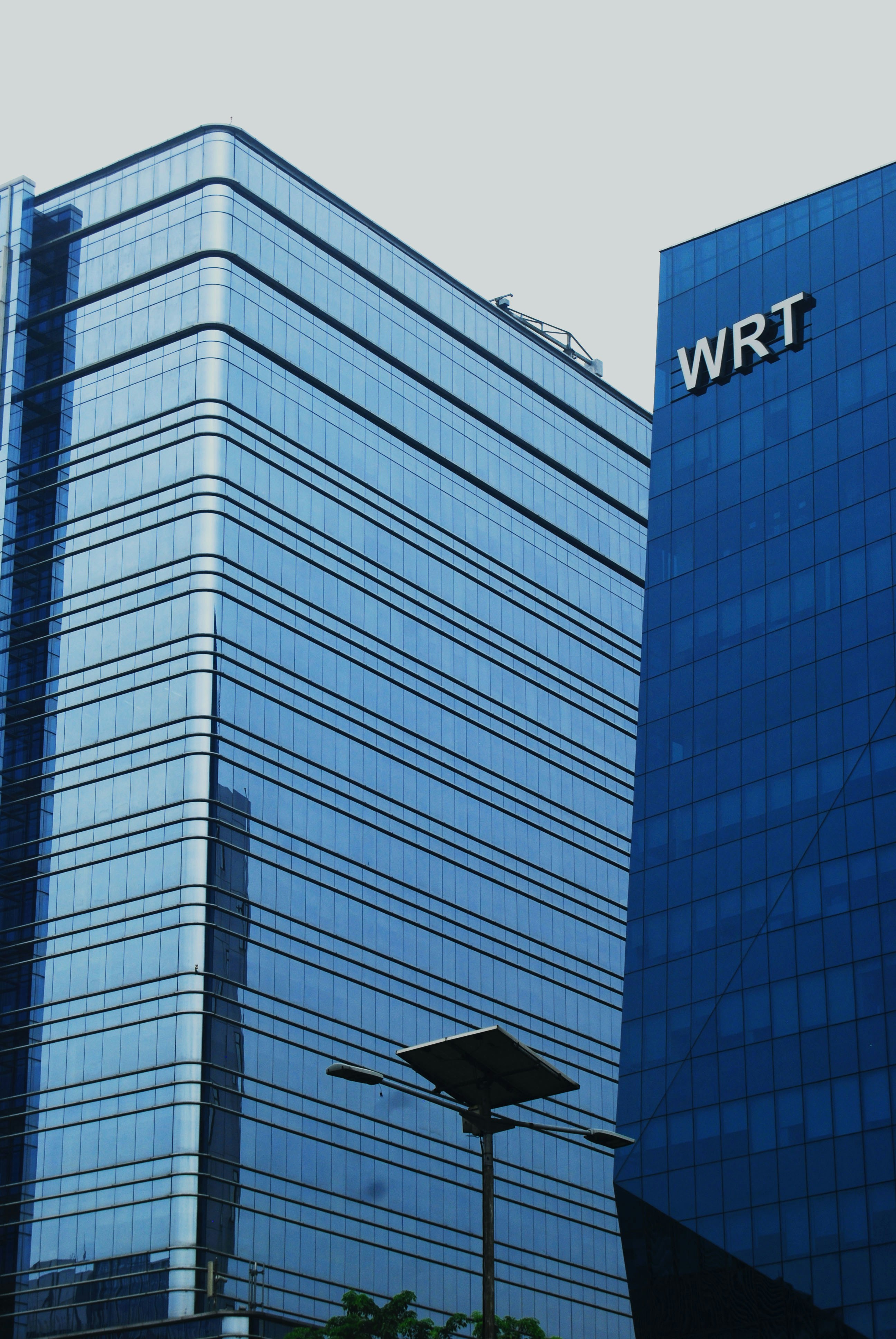 A very tall building with a very large sign on it's side photo – Free ...