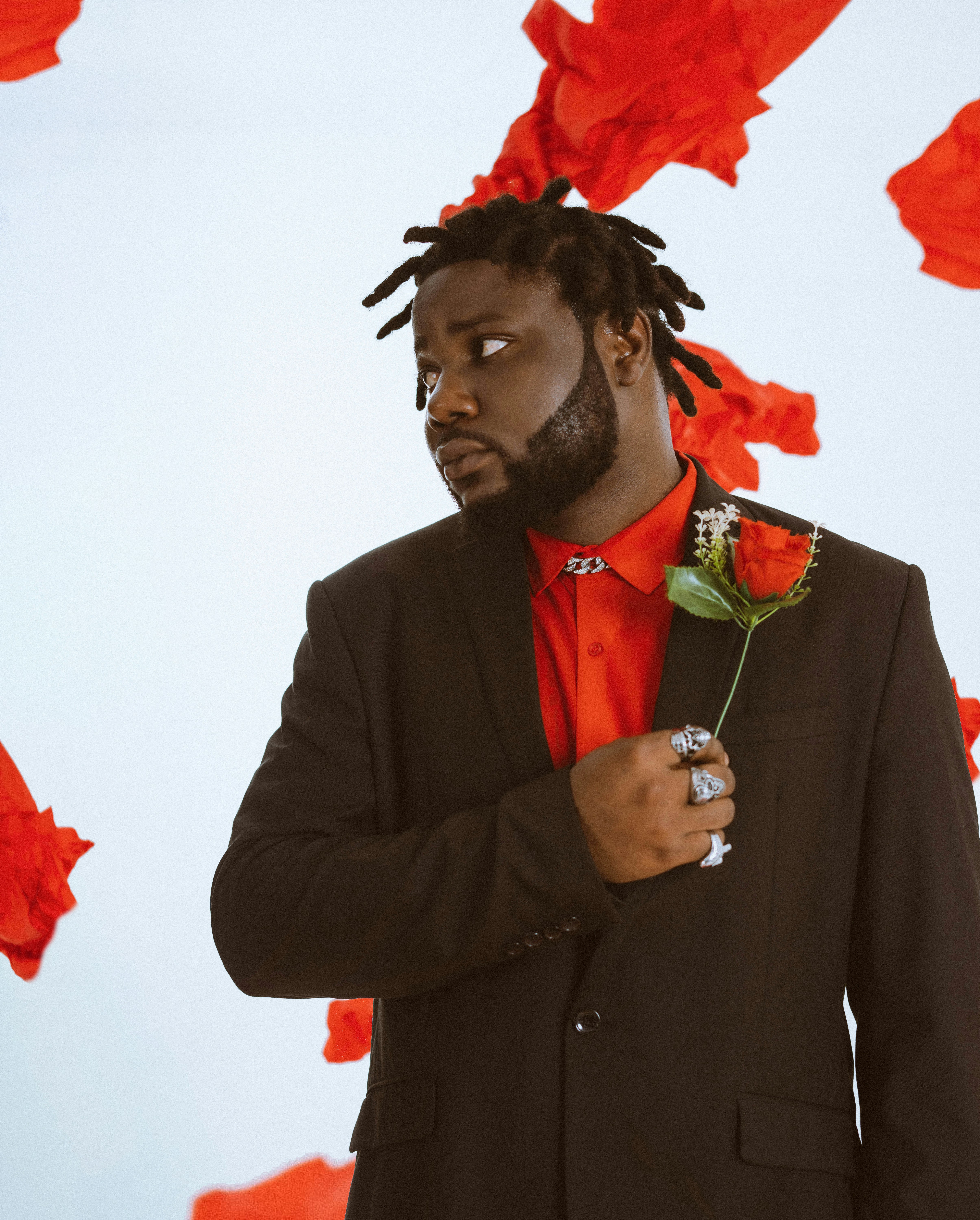 Crimson Confidant: Portrait Amid Floating Petals